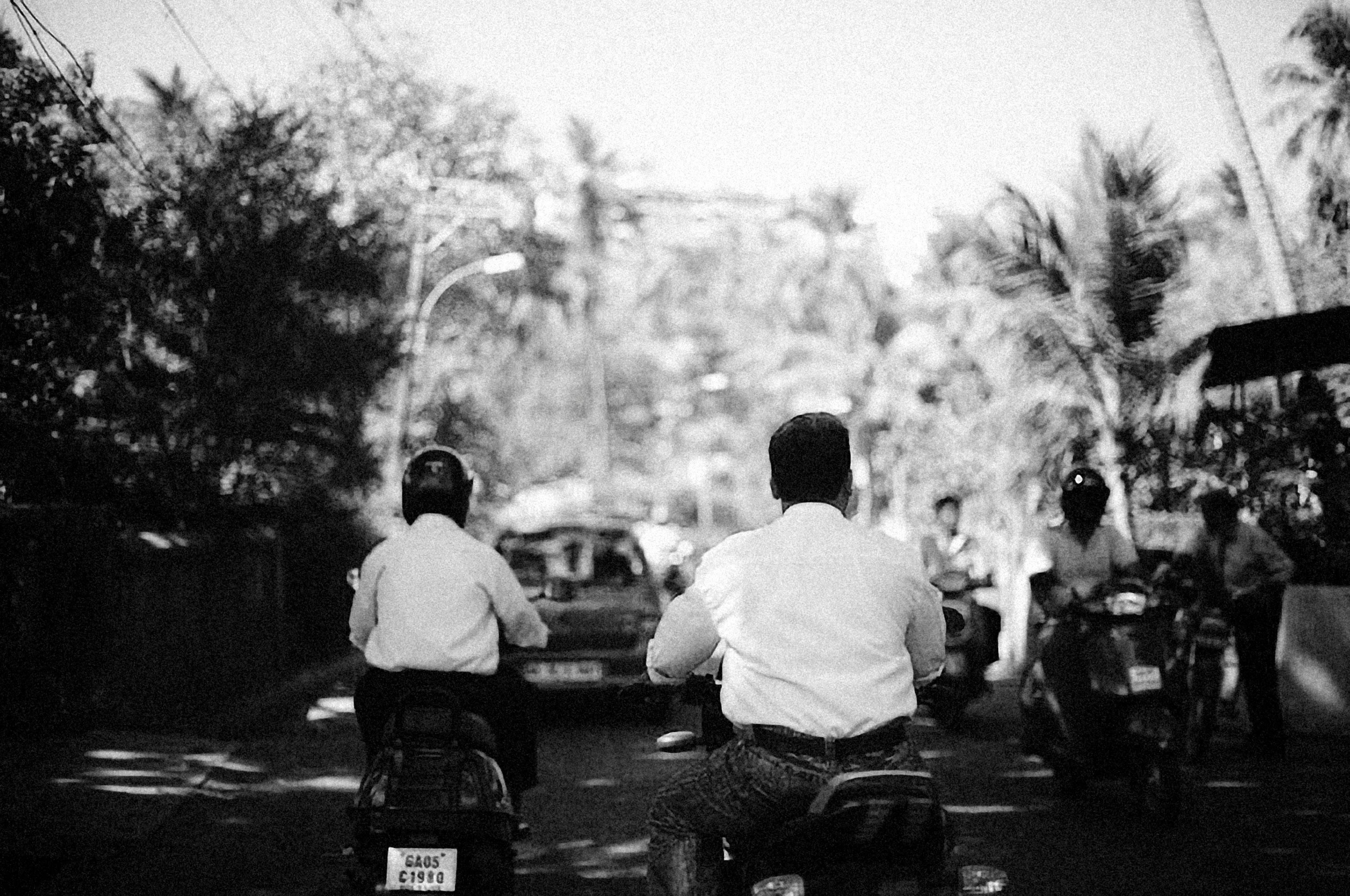 Grayscale Photo of Busy People Riding on their Vehicles on the Road ...