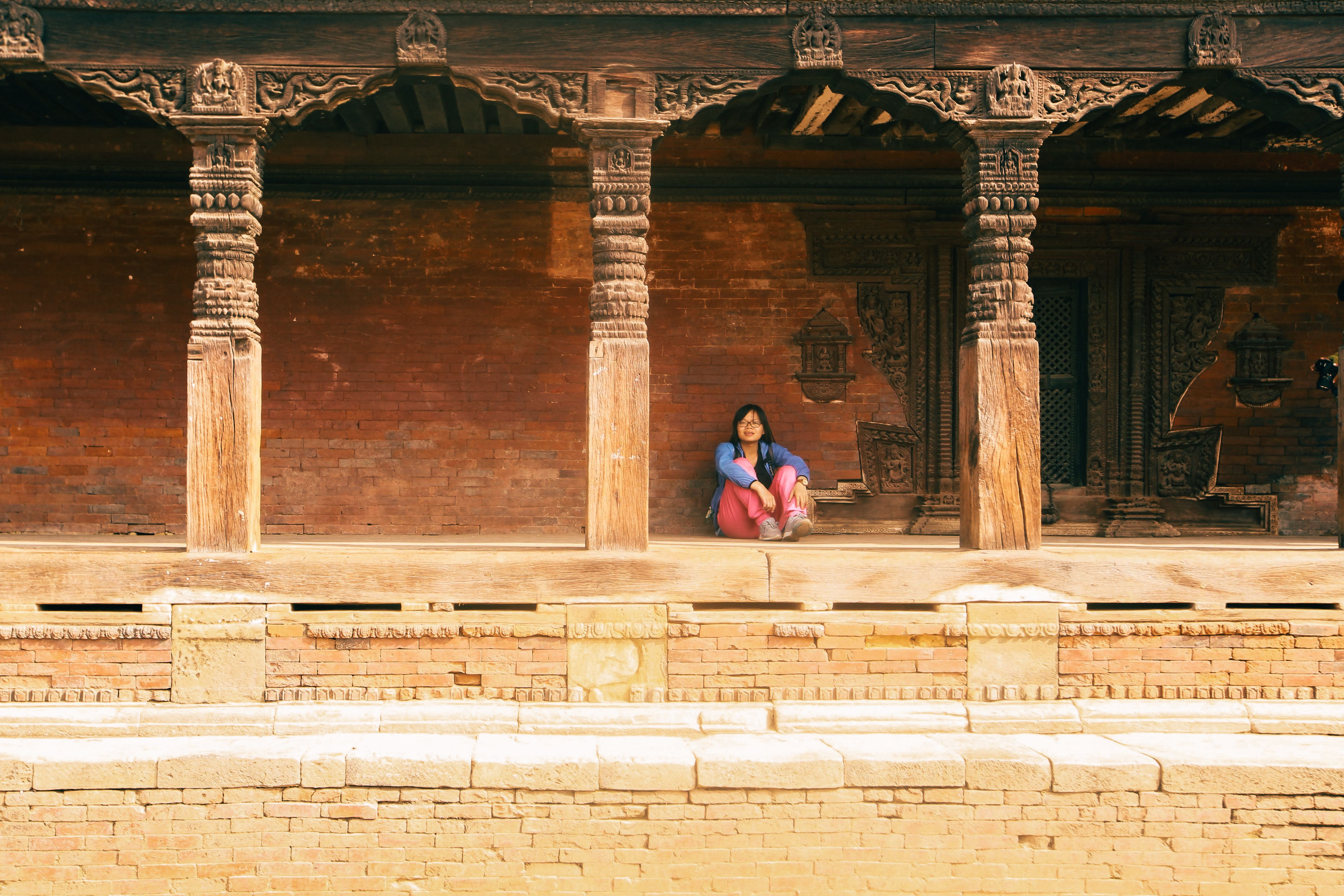 Woman Sitting Between Columns Outside Ancien Architecture Building ...
