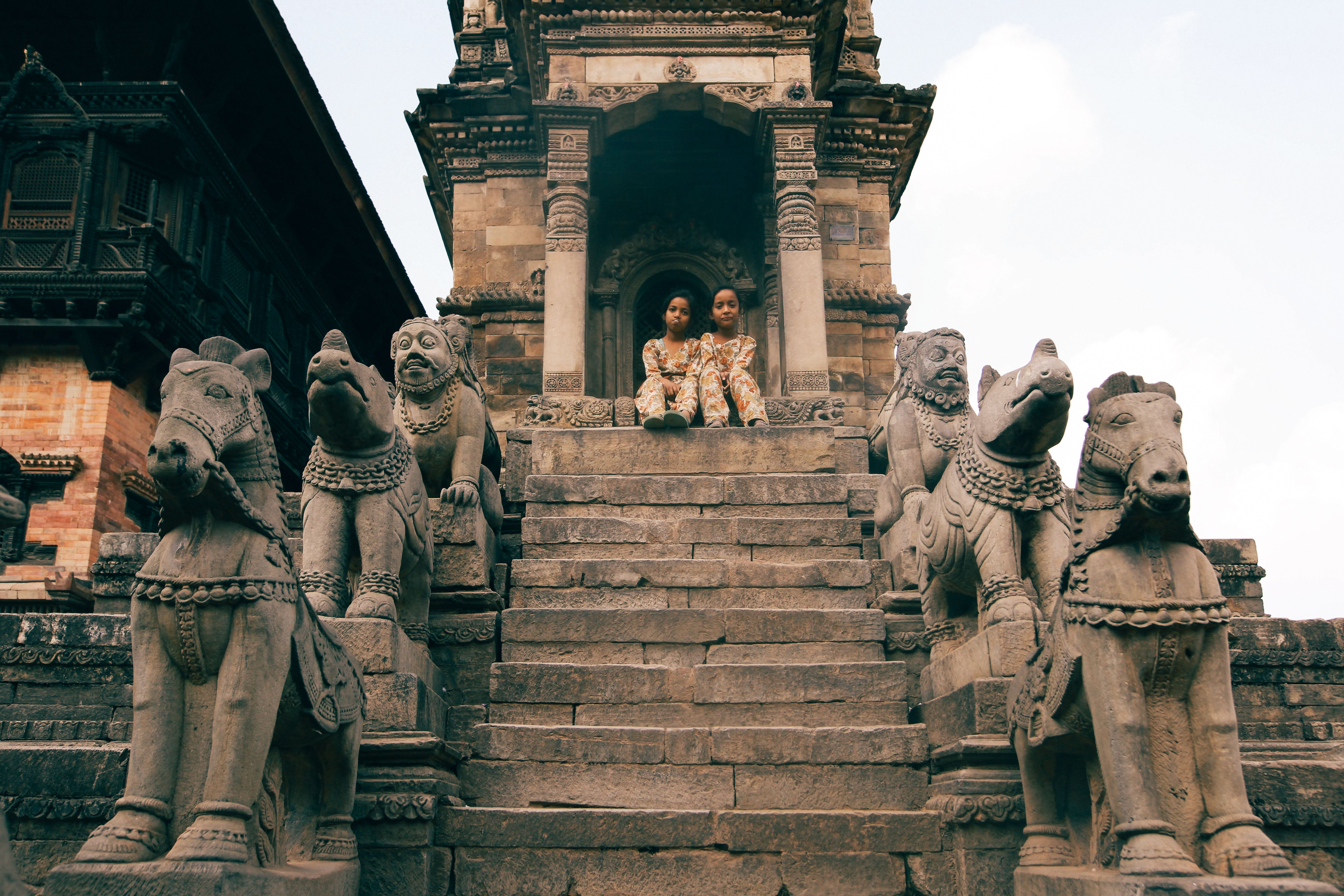 Kids Sitting on Stairs Leading to Temple · Free Stock Photo