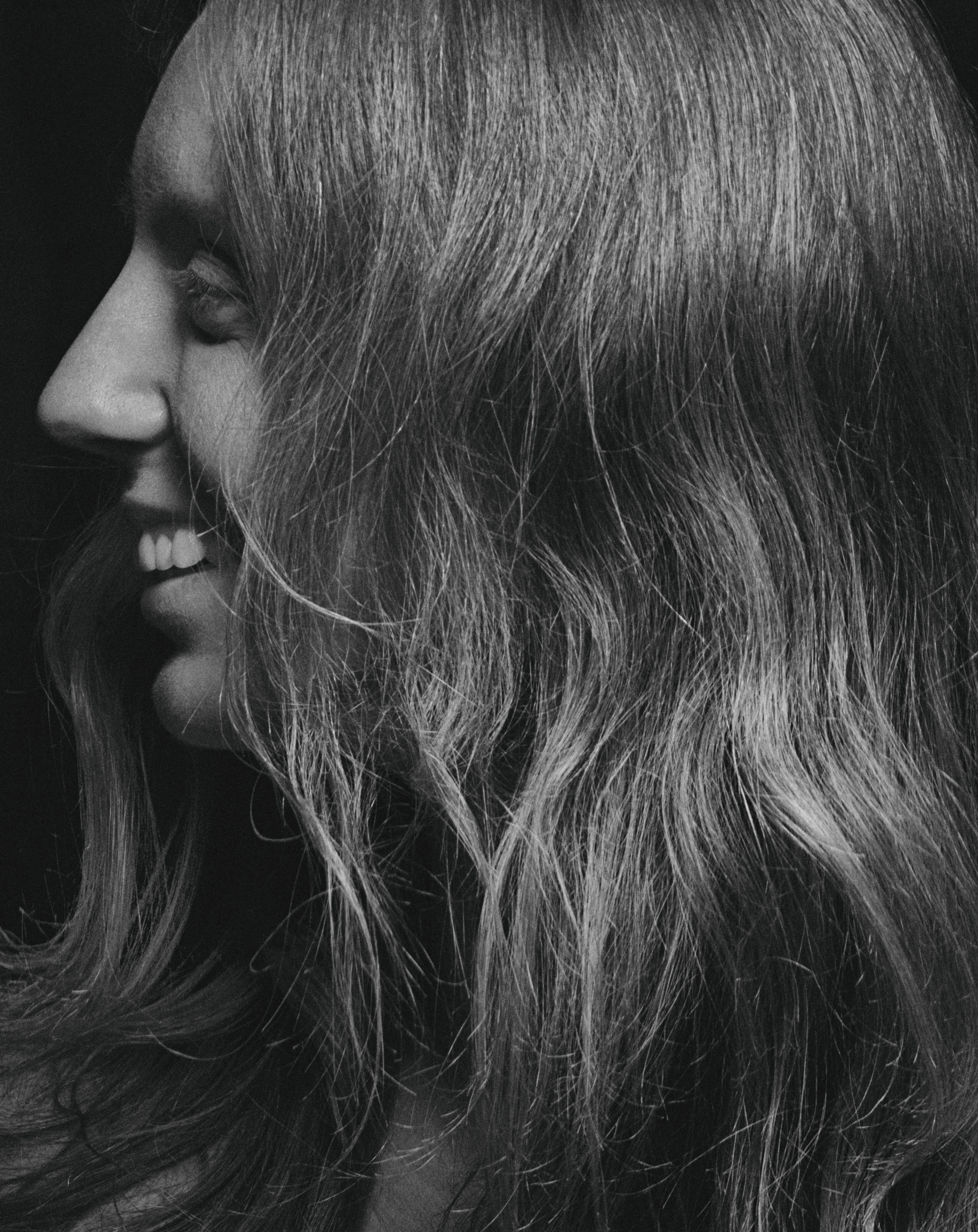 A Side View of a Woman Smiling · Free Stock Photo