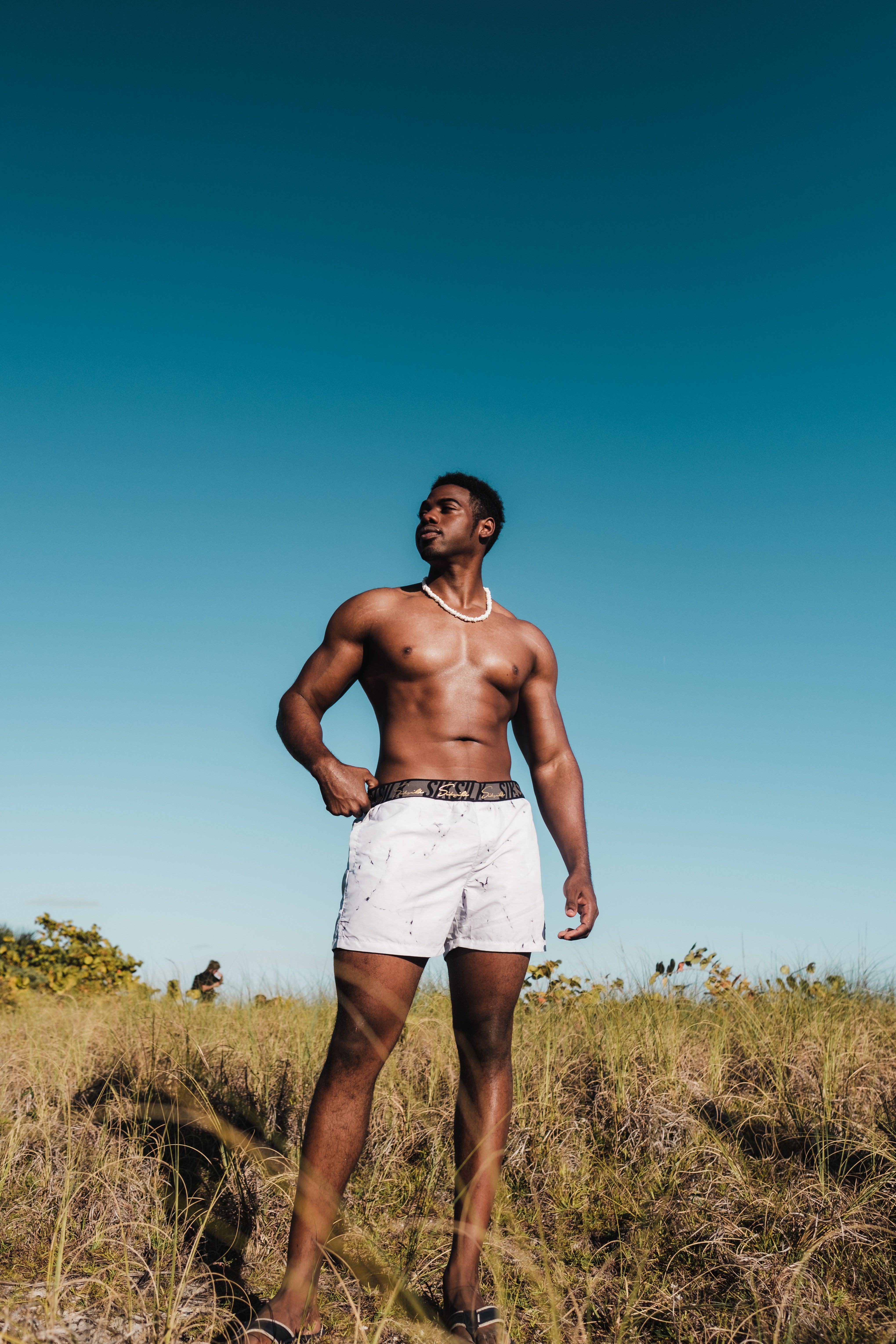 A Shirtless Man Carrying a Concrete Block on His Back · Free Stock Photo