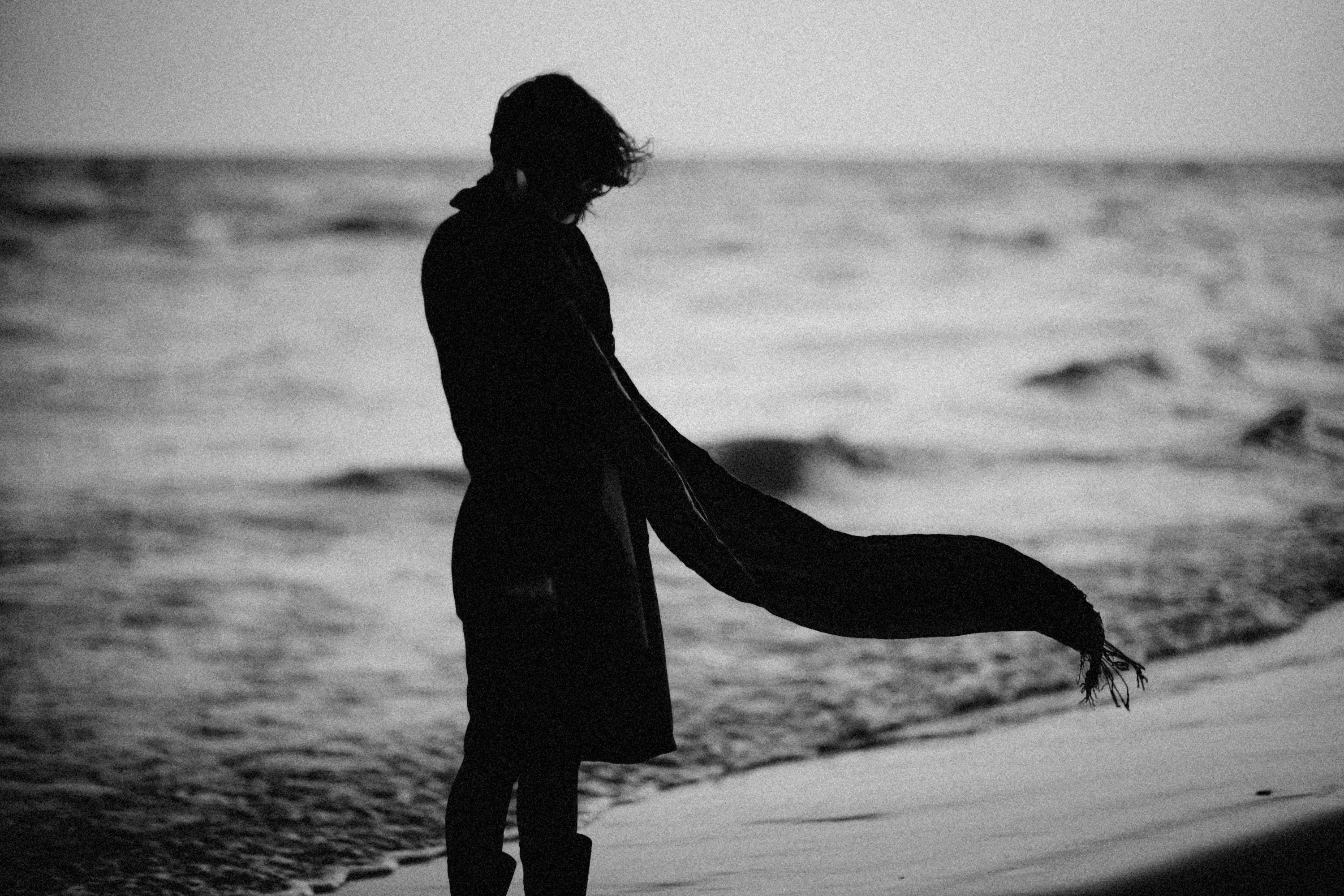Grayscale Photo of People at a Beach · Free Stock Photo