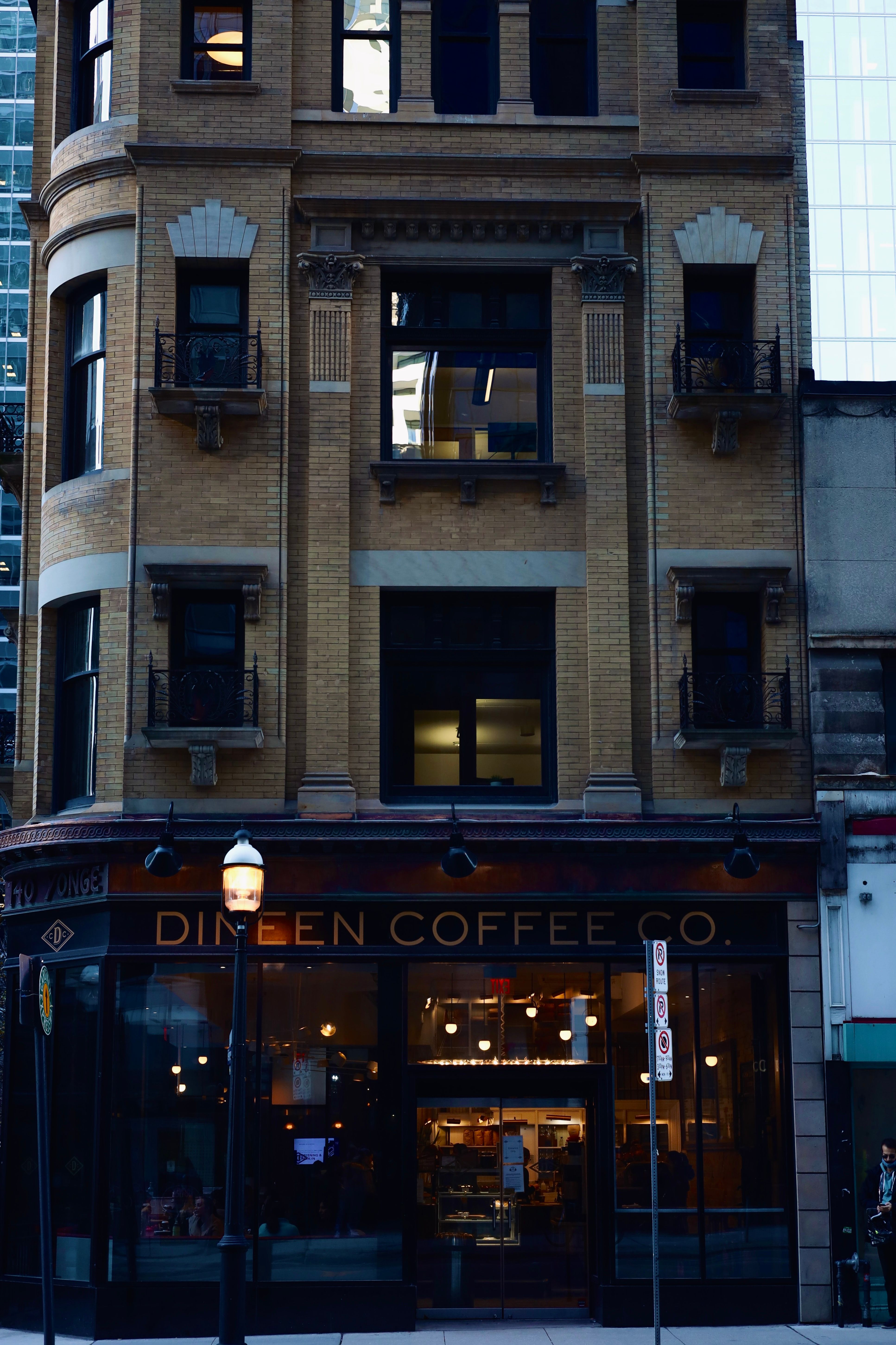 A Coffee Shop on Brown Brick Building · Free Stock Photo