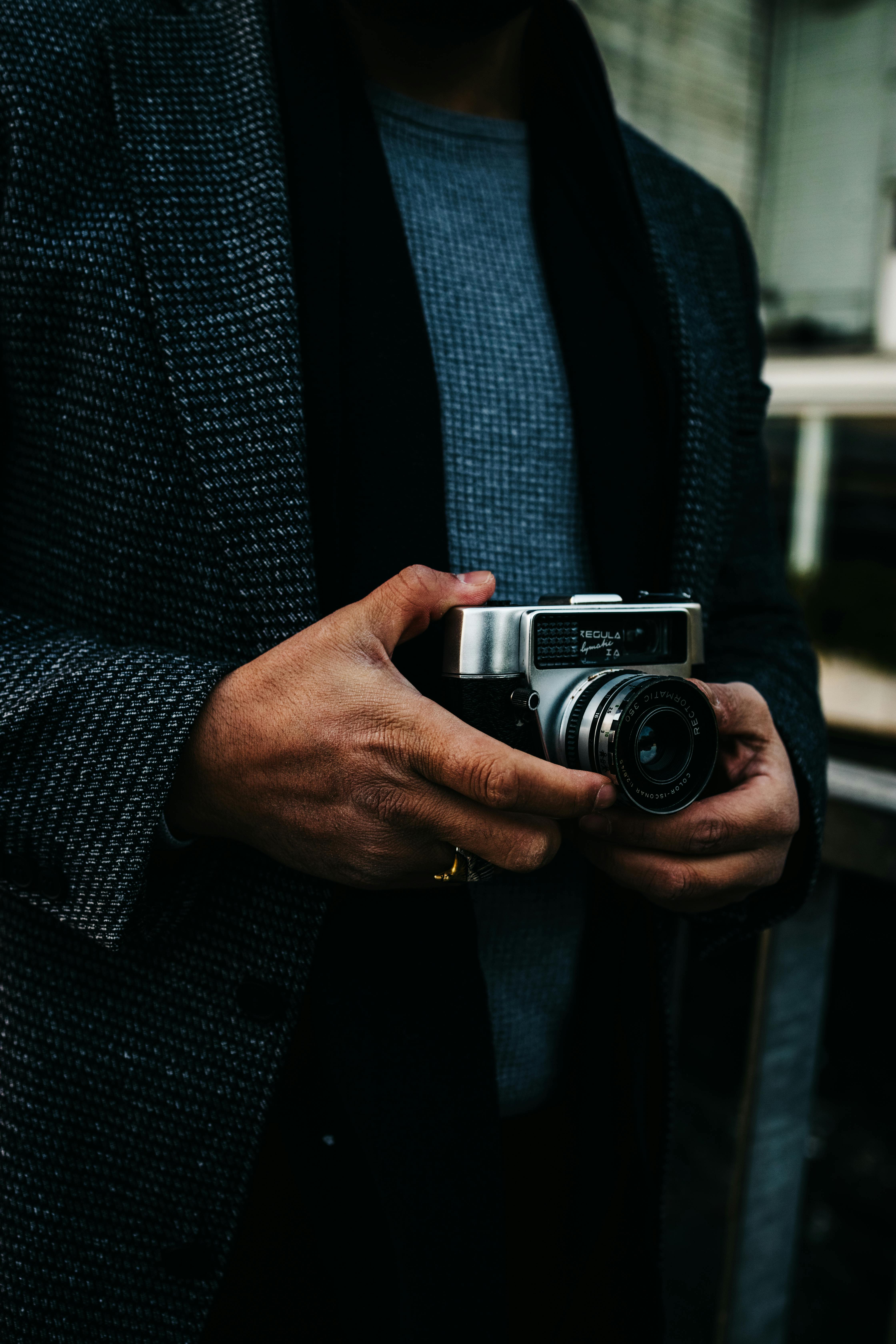 Close Up Photo of a Person Holding a Camera · Free Stock Photo