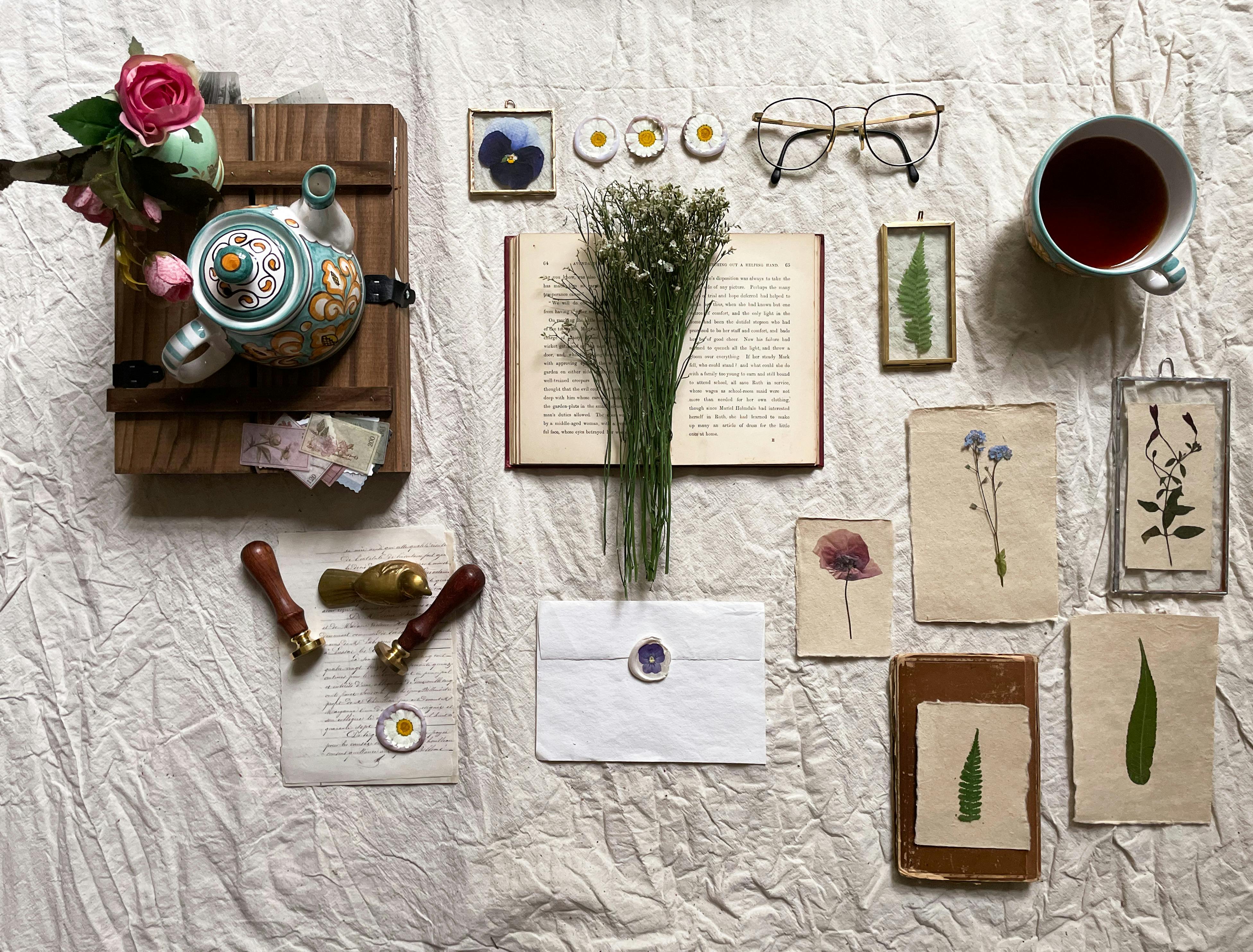 Flat Lay of Vintage Items and Flower Paintings · Free Stock Photo