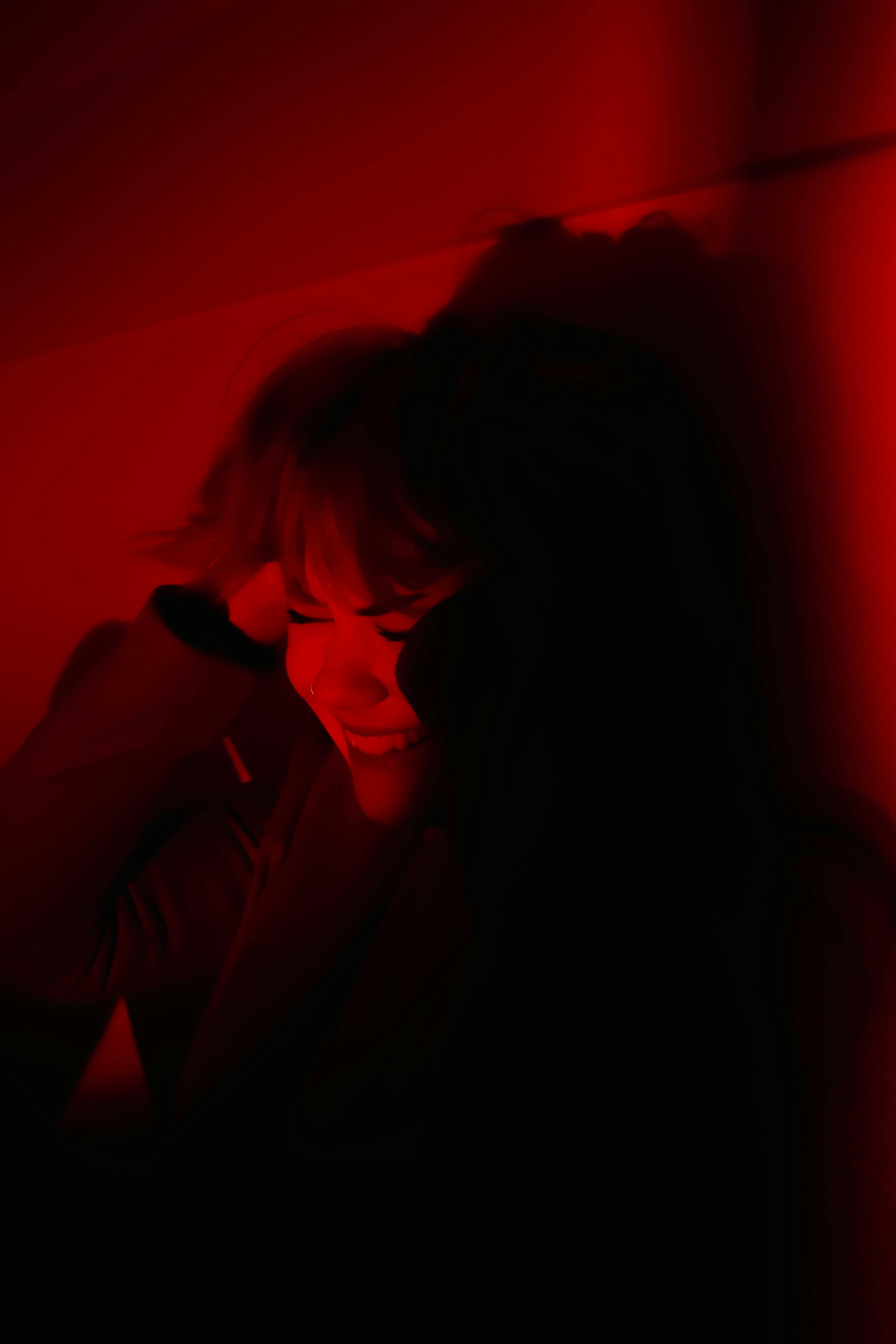 Moody Portrait of Woman in Red Lighting Outdoors · Free Stock Photo