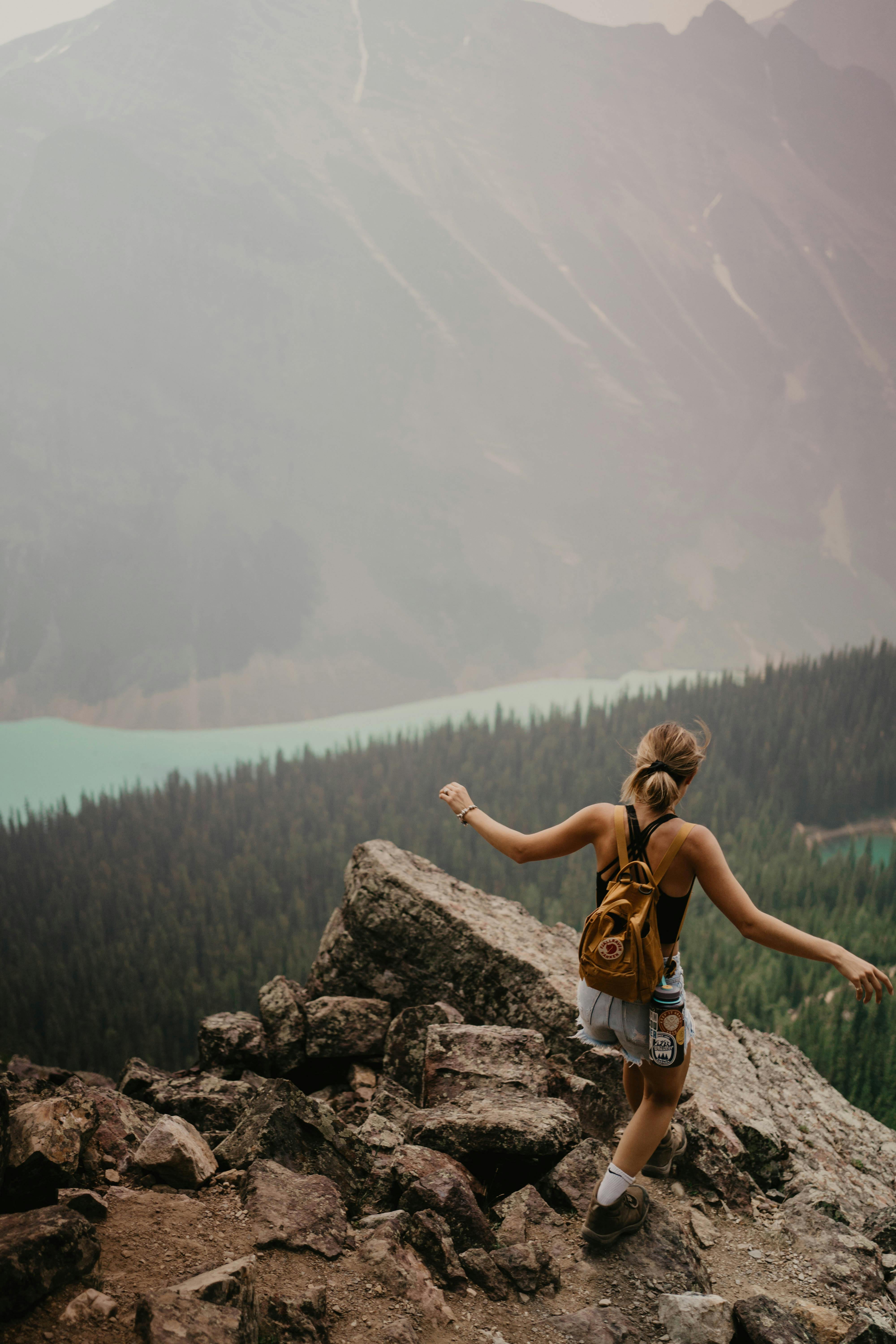 Hiker on a Mountain Looking Down · Free Stock Photo