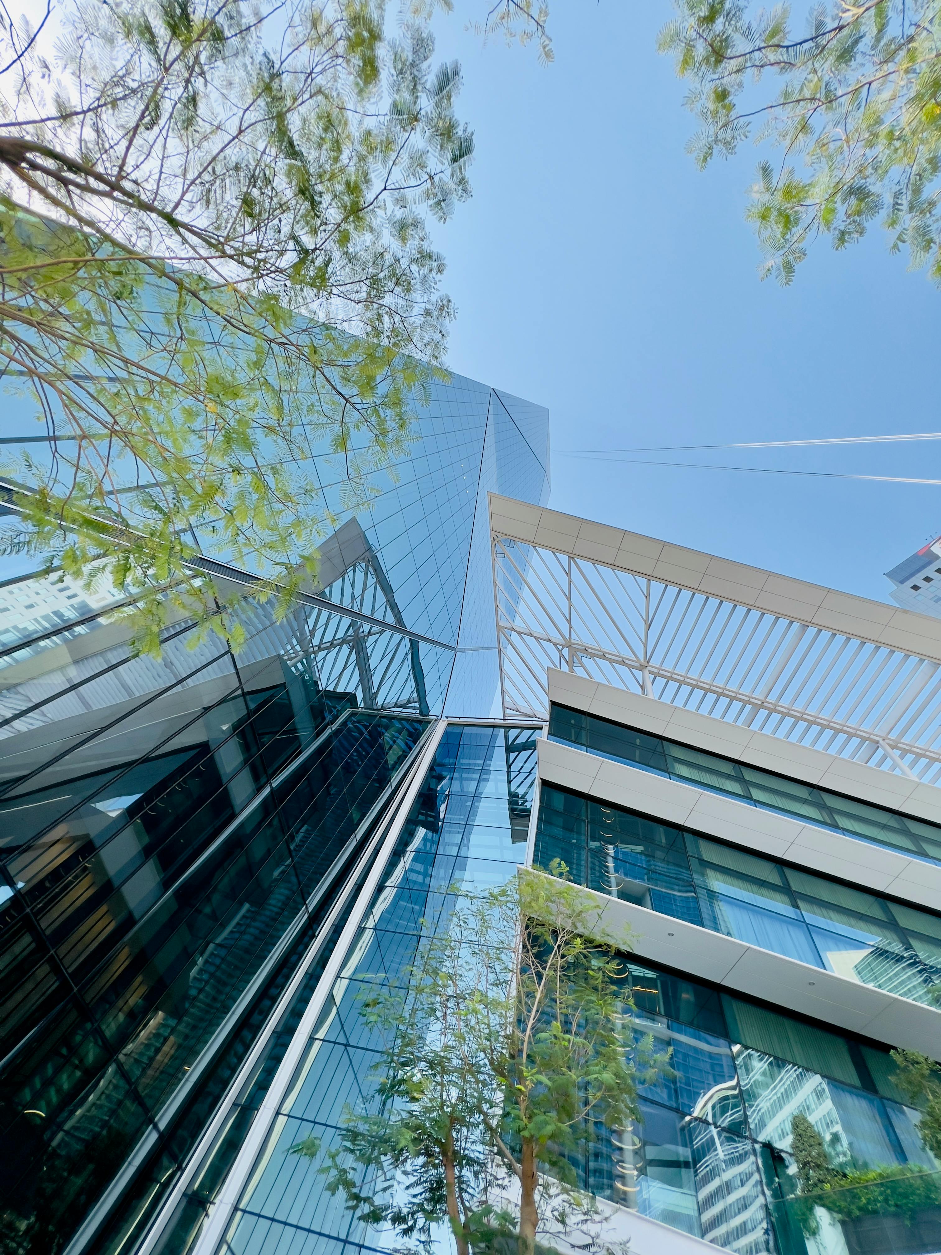 Low Angle Shot of a Glass High Rise Building · Free Stock Photo