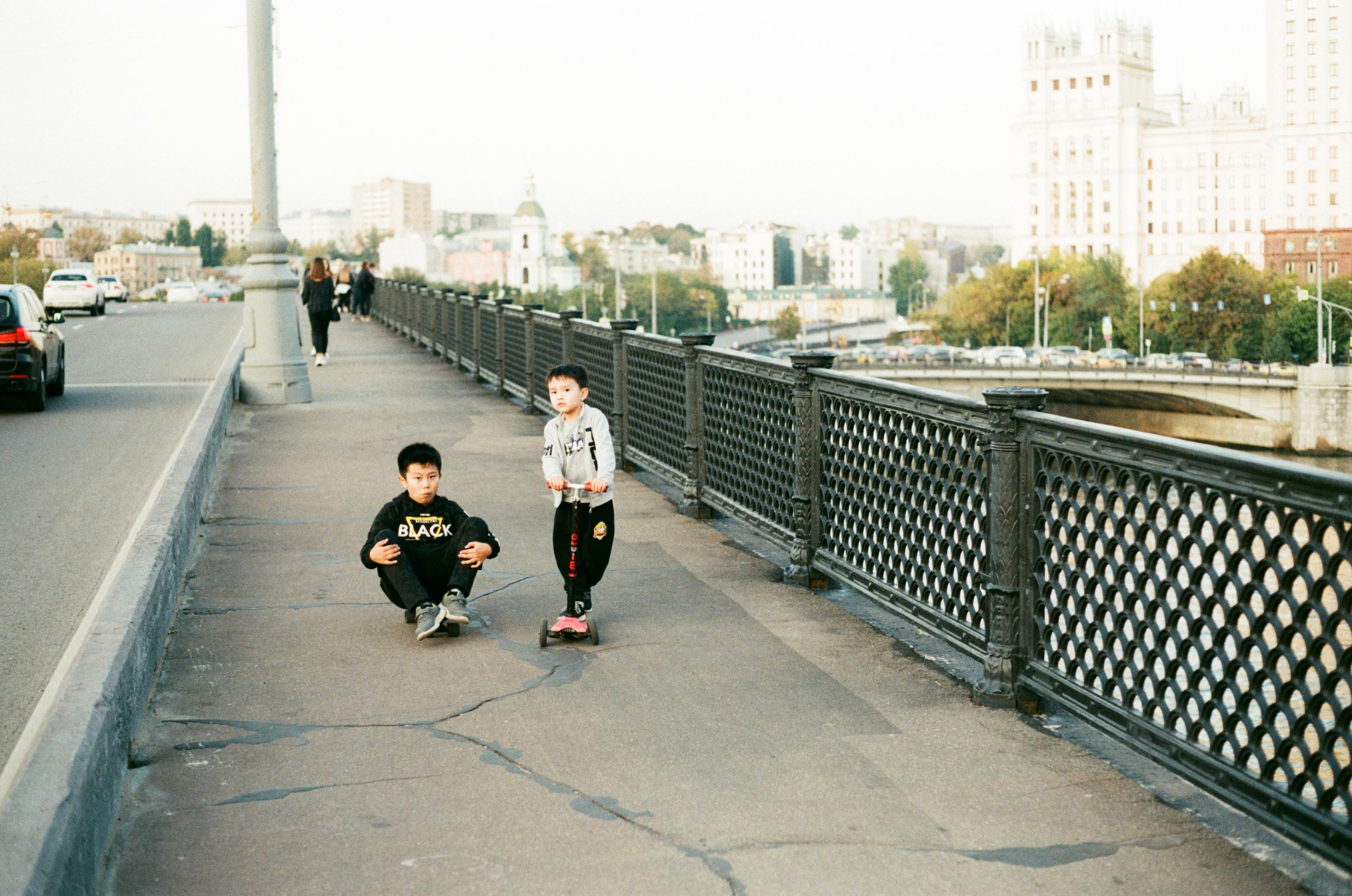 Children Sitting on Rail Tracks · Free Stock Photo