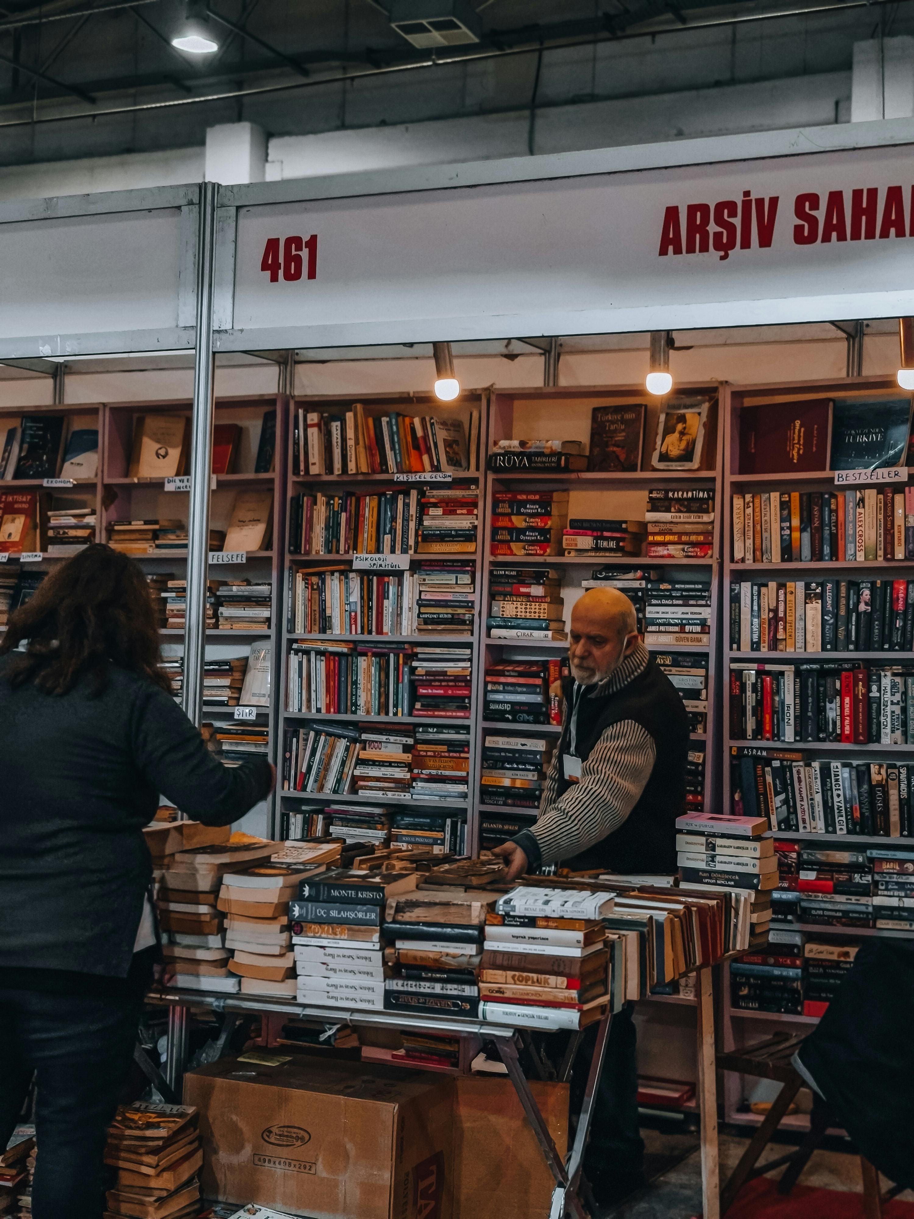 Man Getting a Book from a Bookcase · Free Stock Photo