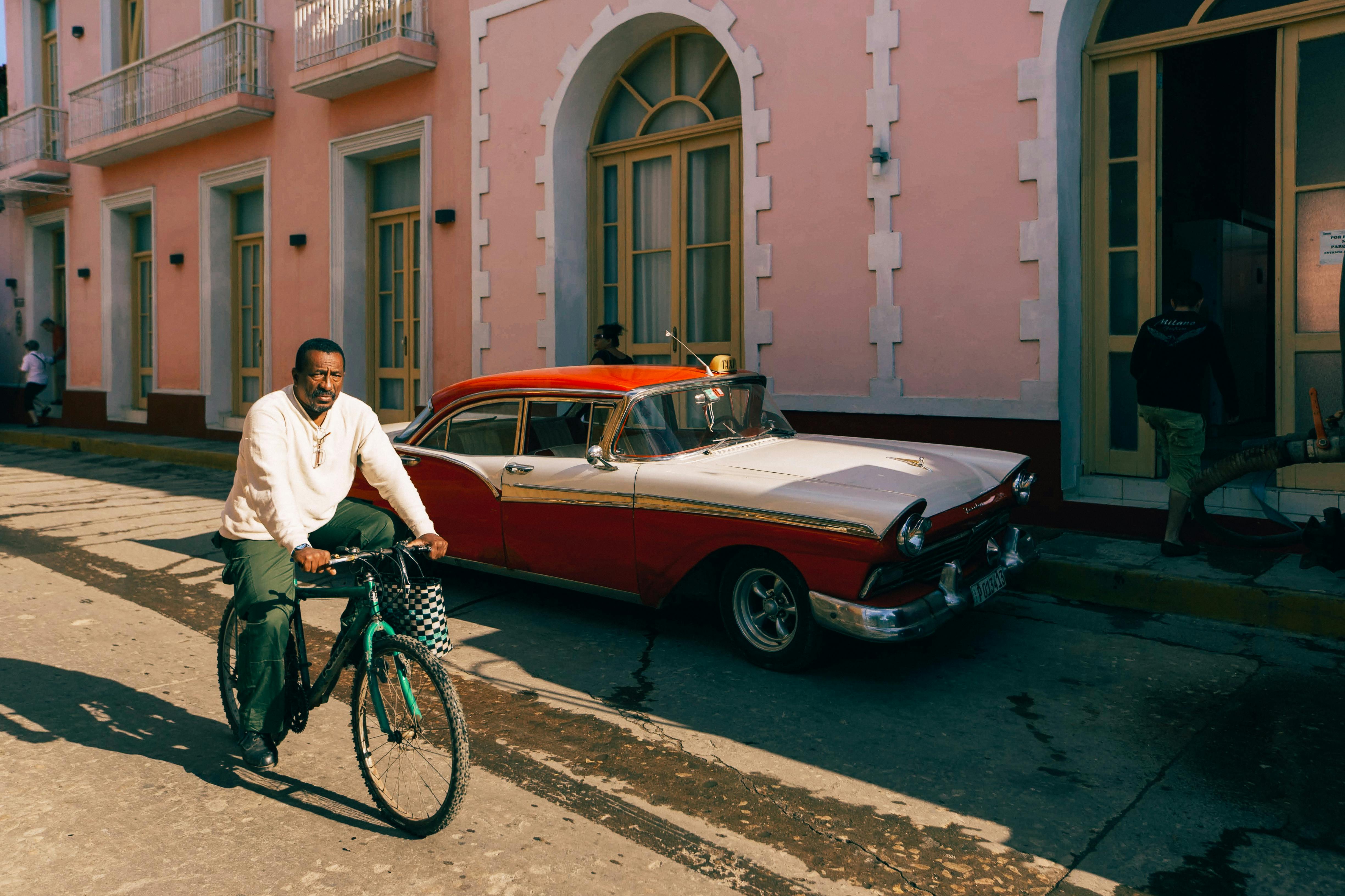 Man Riding Bicycle on City Street · Free Stock Photo