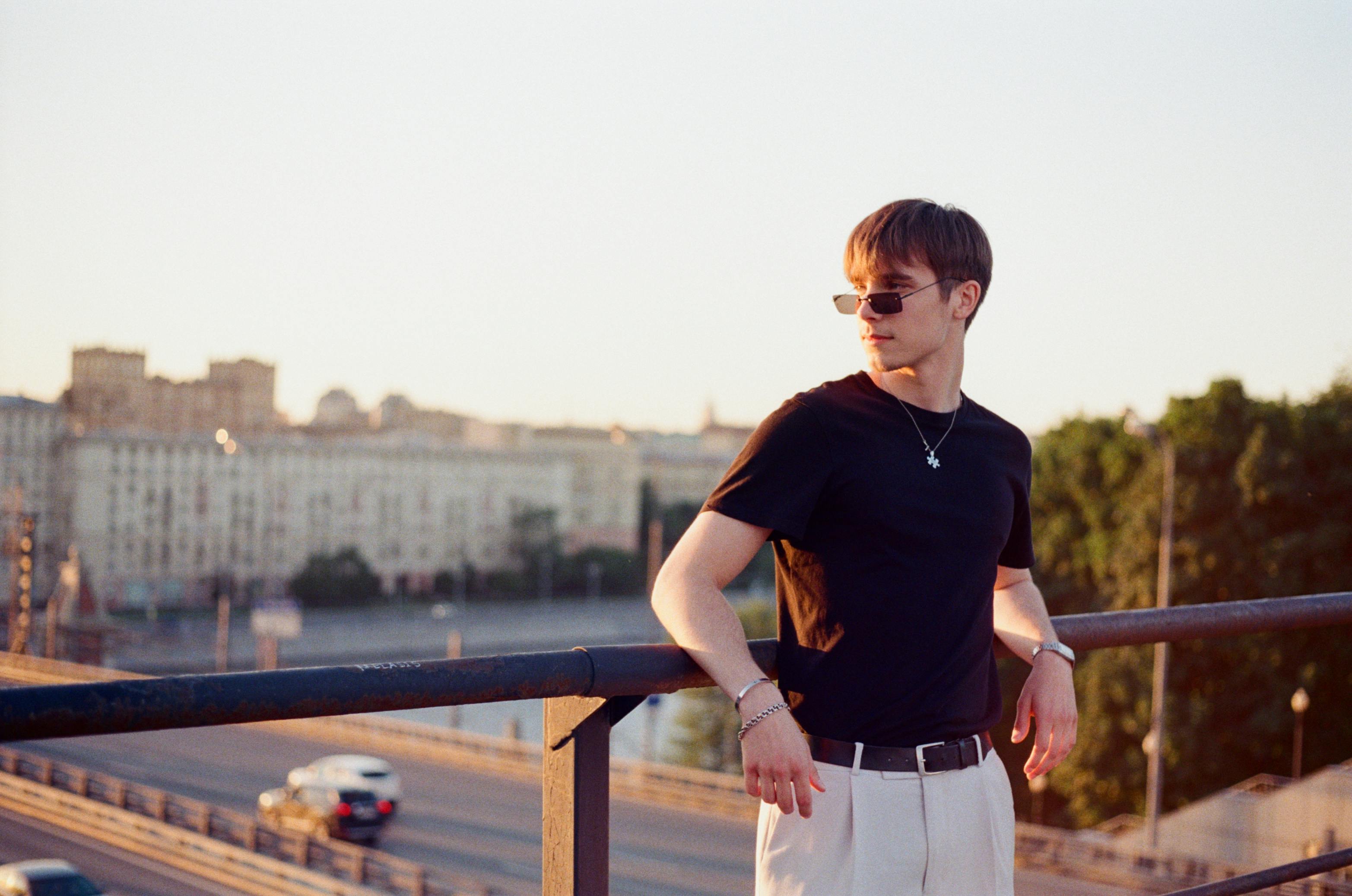 Person in Black Shirt Leaning on Railing · Free Stock Photo