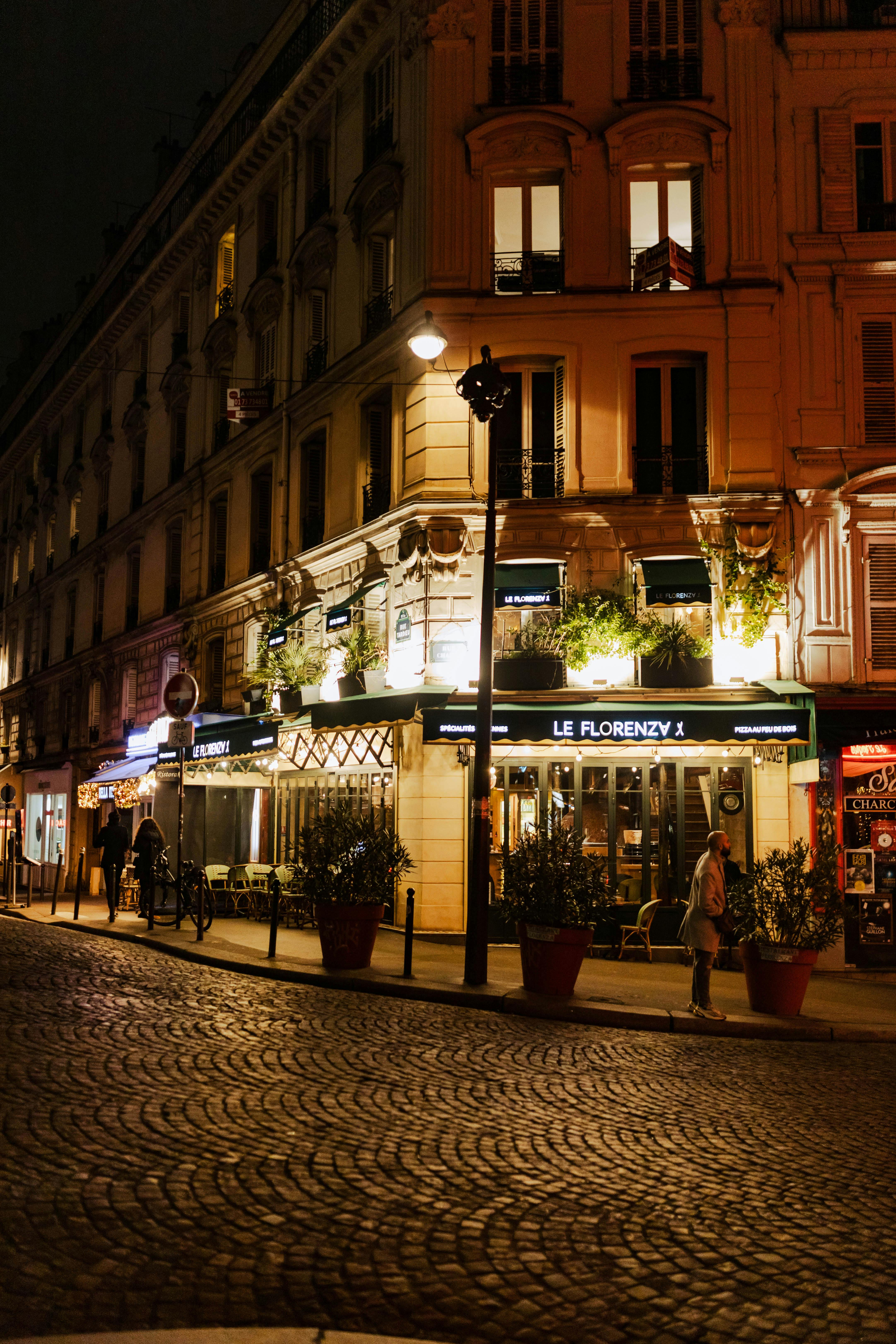 Charming Parisian Street Scene with Cafe and Cobblestone · Free Stock Photo