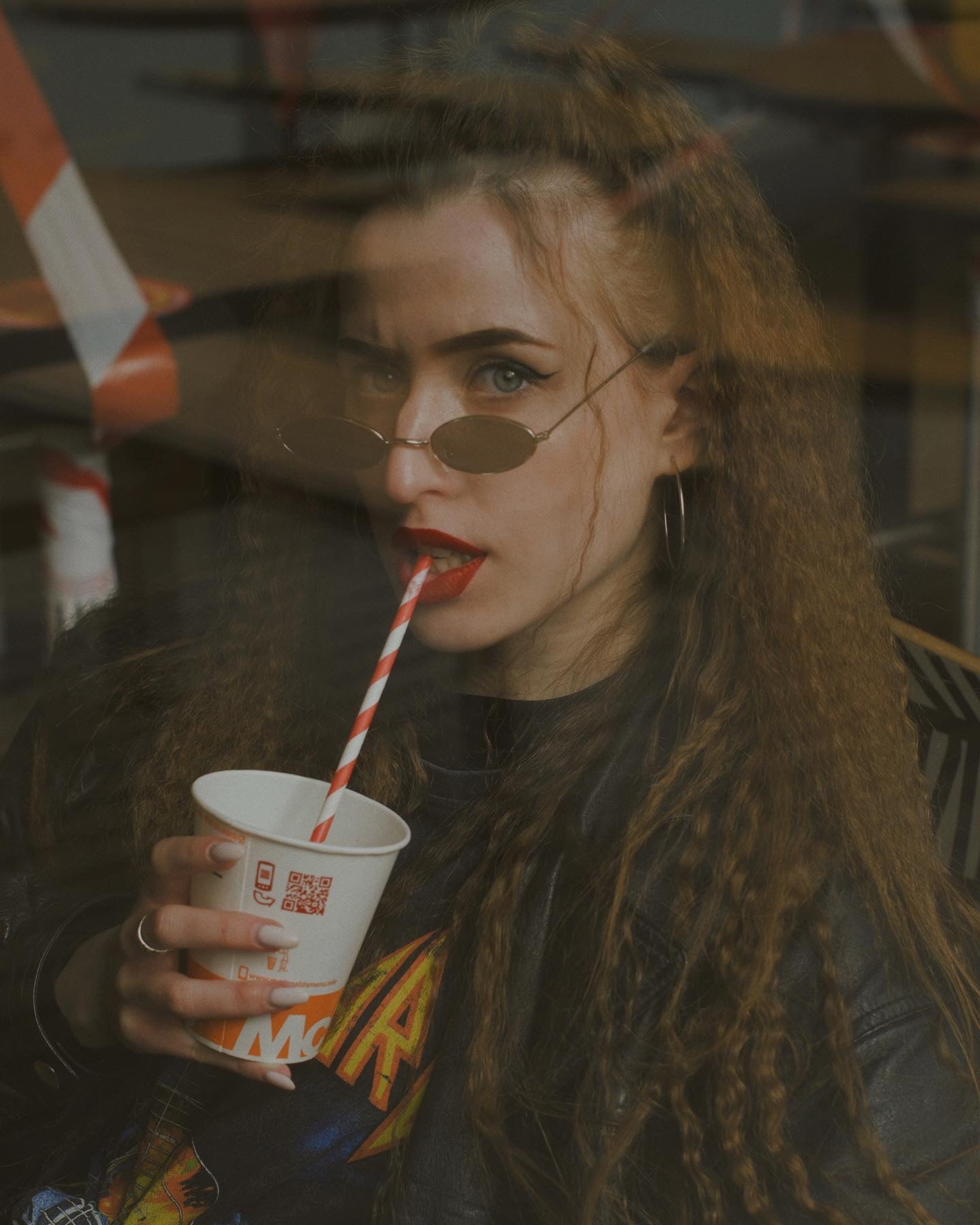 A Woman Sipping With a Straw · Free Stock Photo