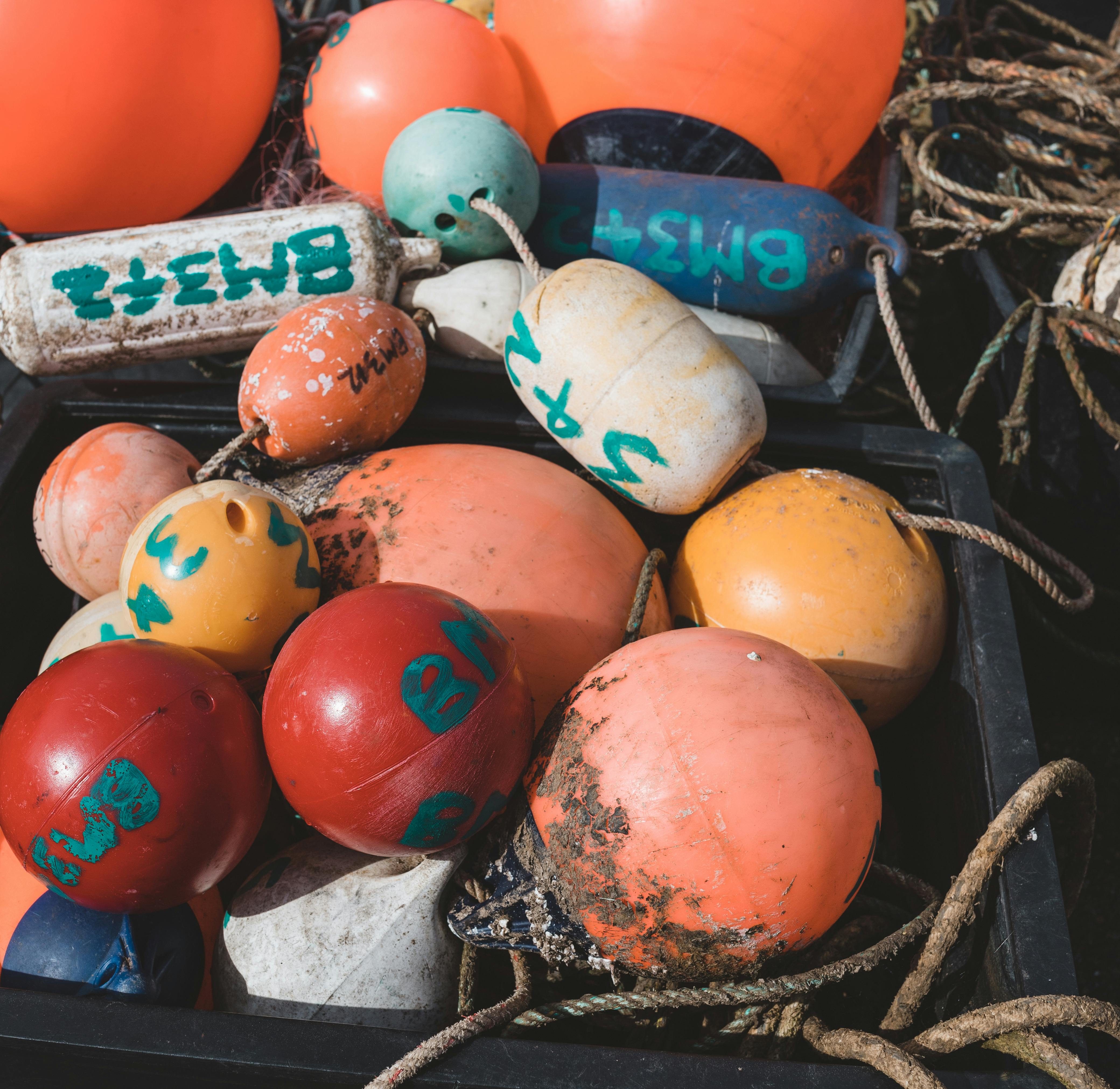 A Set of Red and White Fishnet Floater with Brown Rope · Free Stock Photo