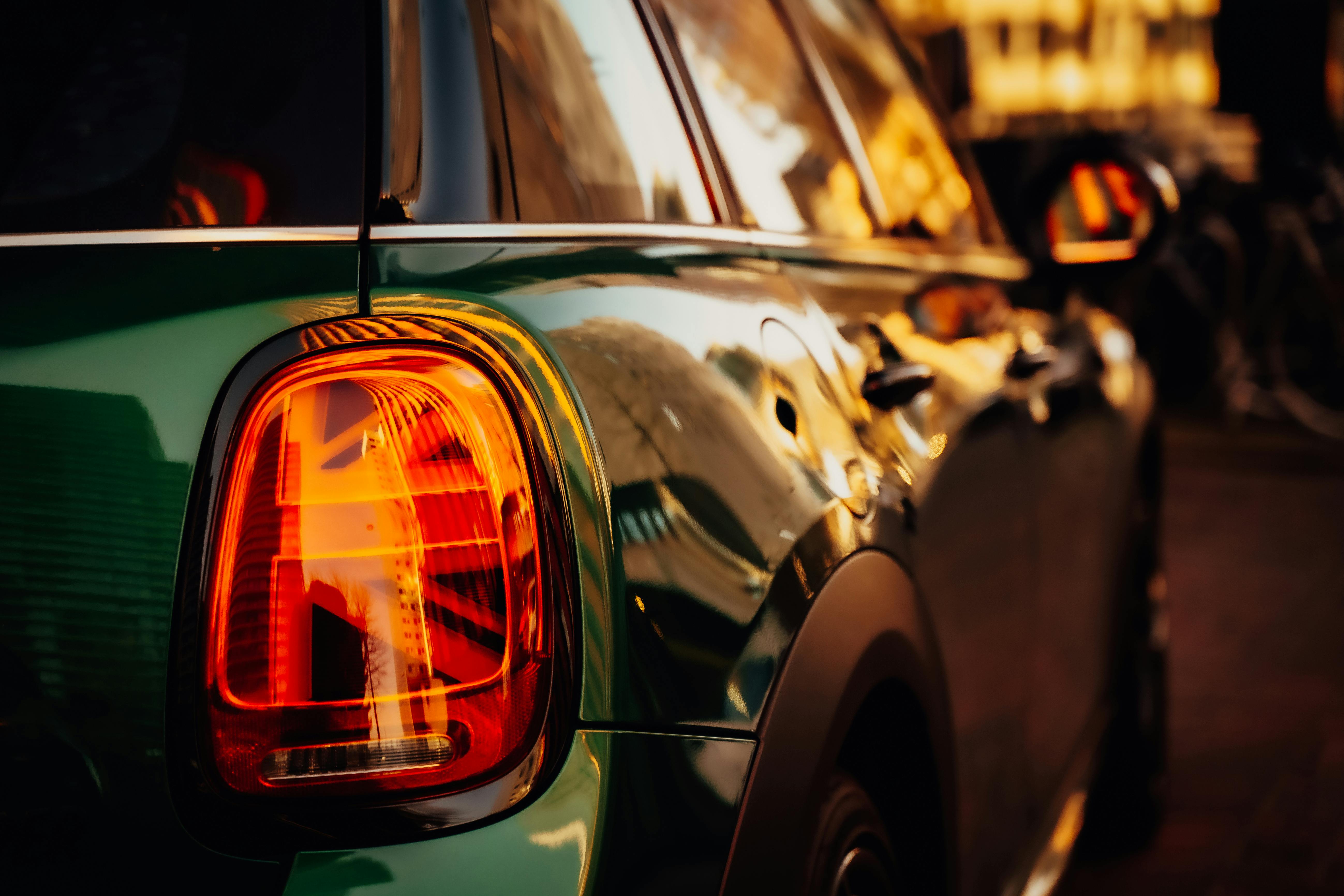 Green Shiny Car ib Close Up Photography · Free Stock Photo