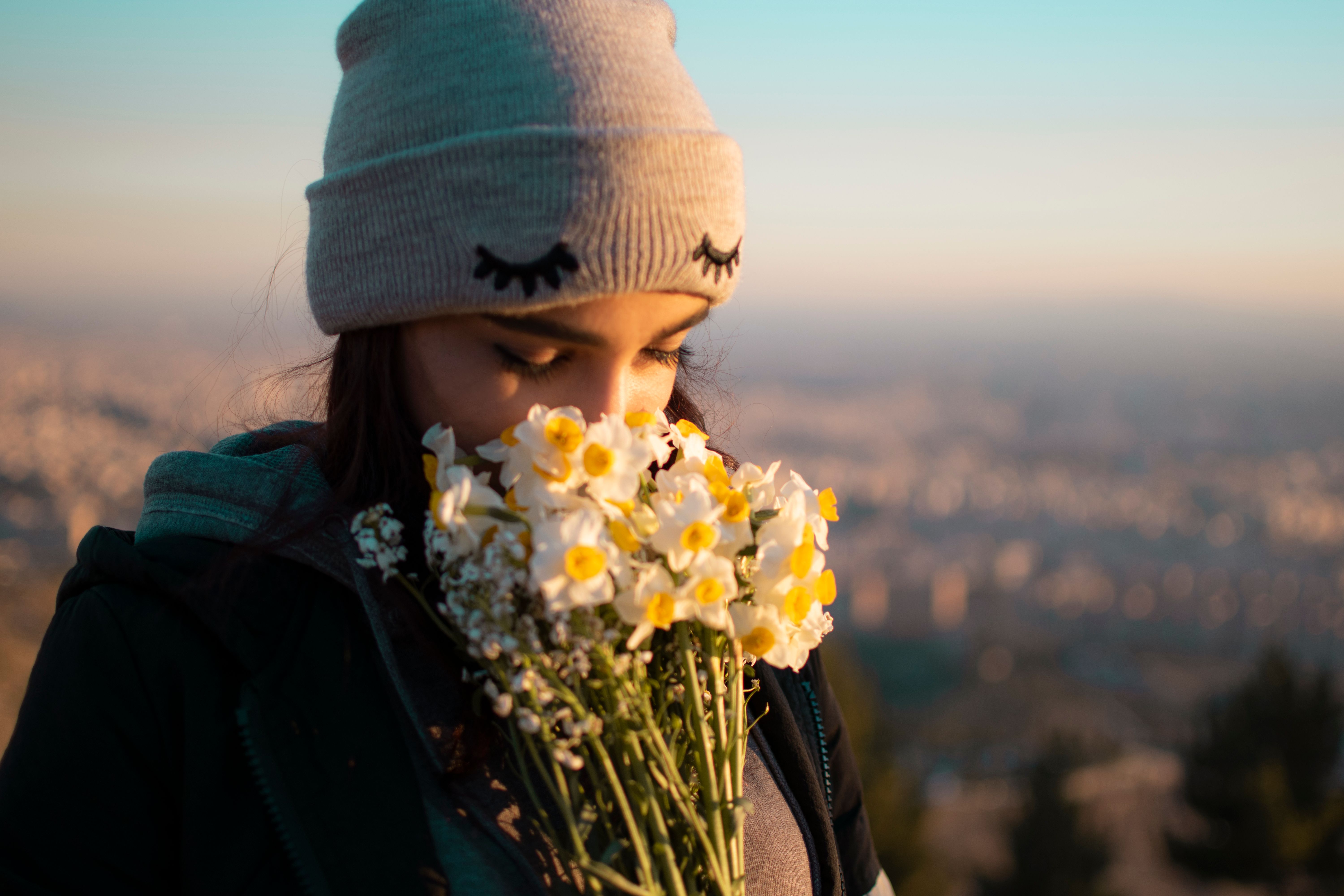 Photo of Woman Smelling Yellow Flower · Free Stock Photo