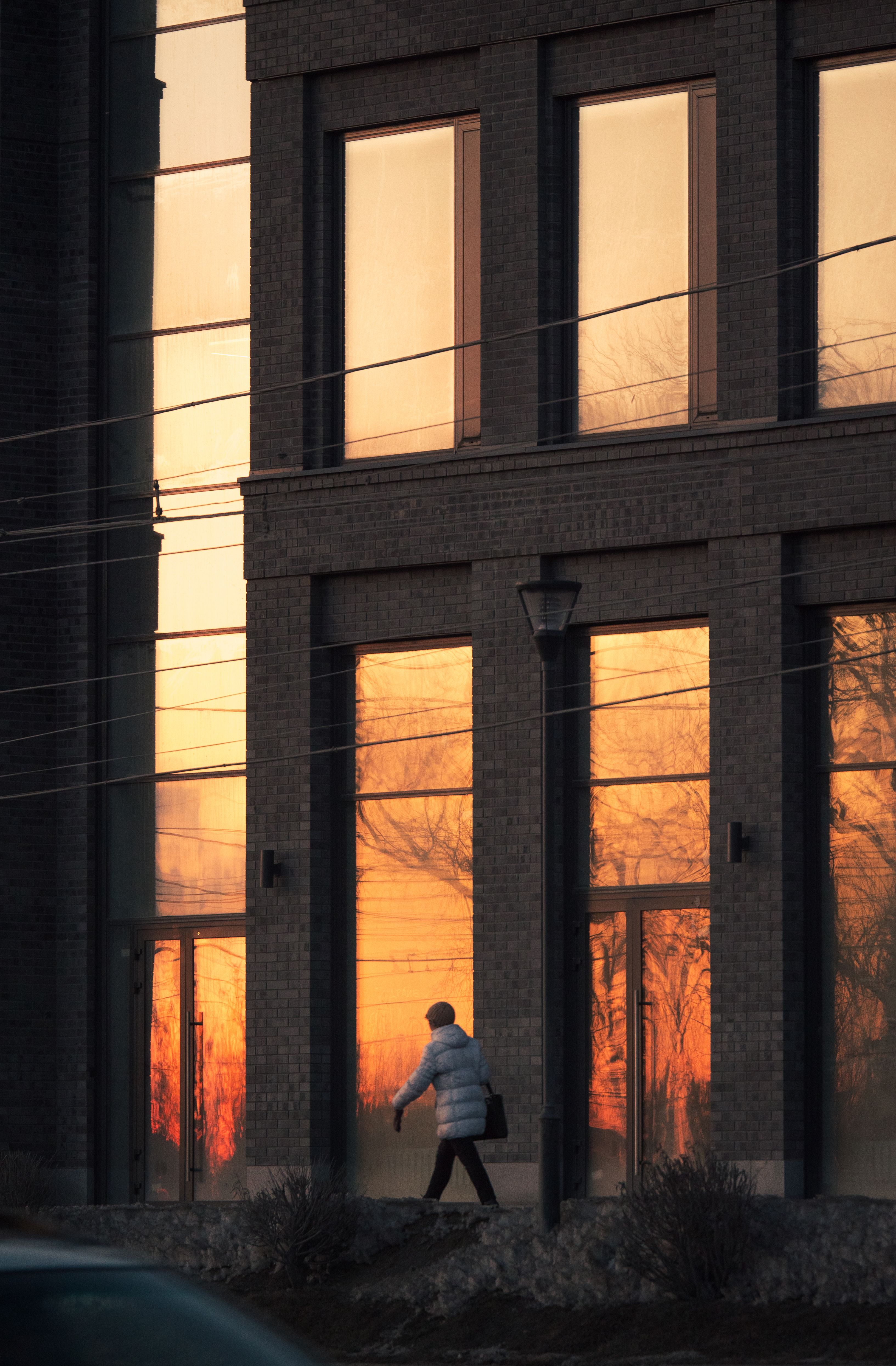 People Walking Outside a Bricked Wall Building · Free Stock Photo