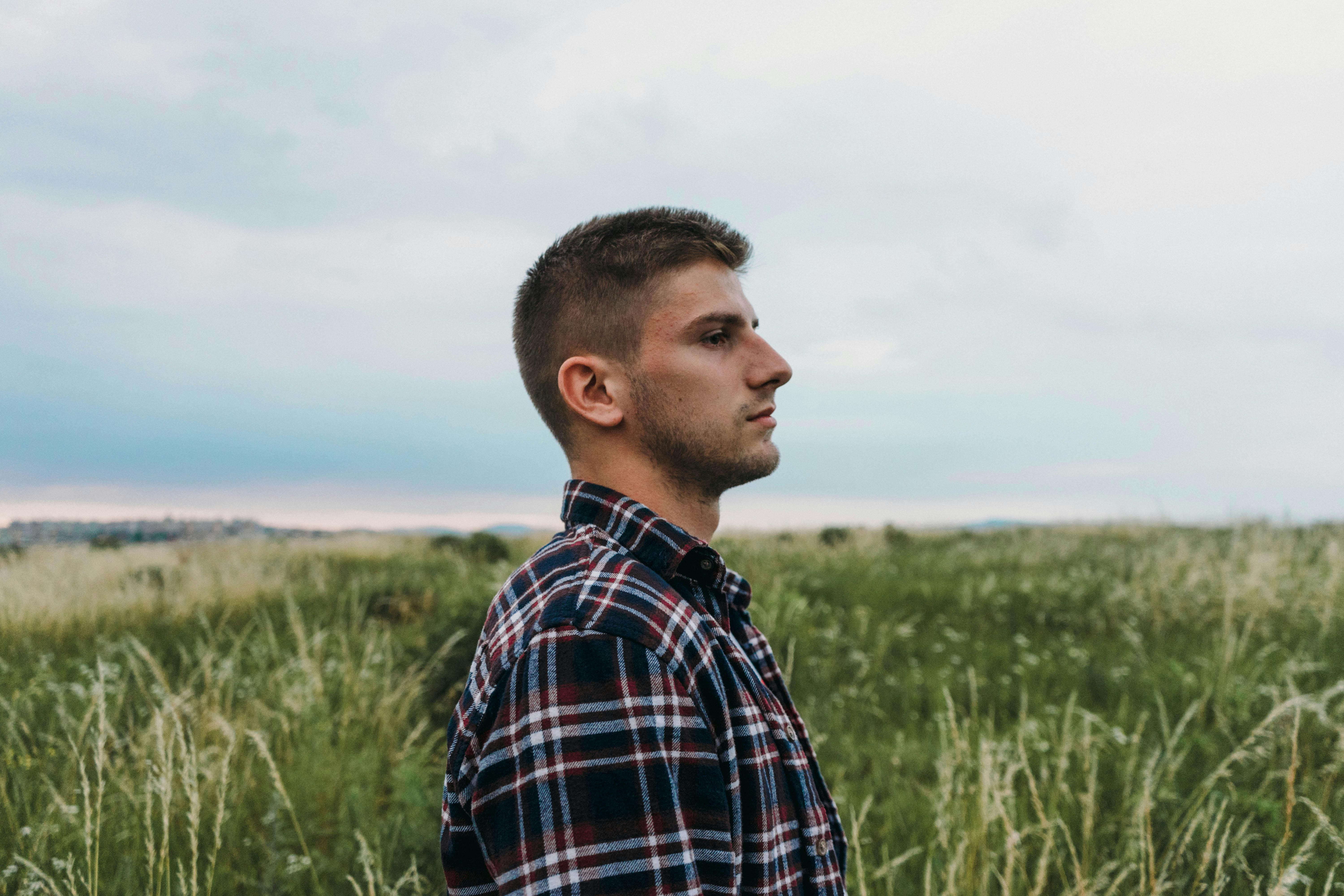 Man Walking Green Field at Daytime · Free Stock Photo