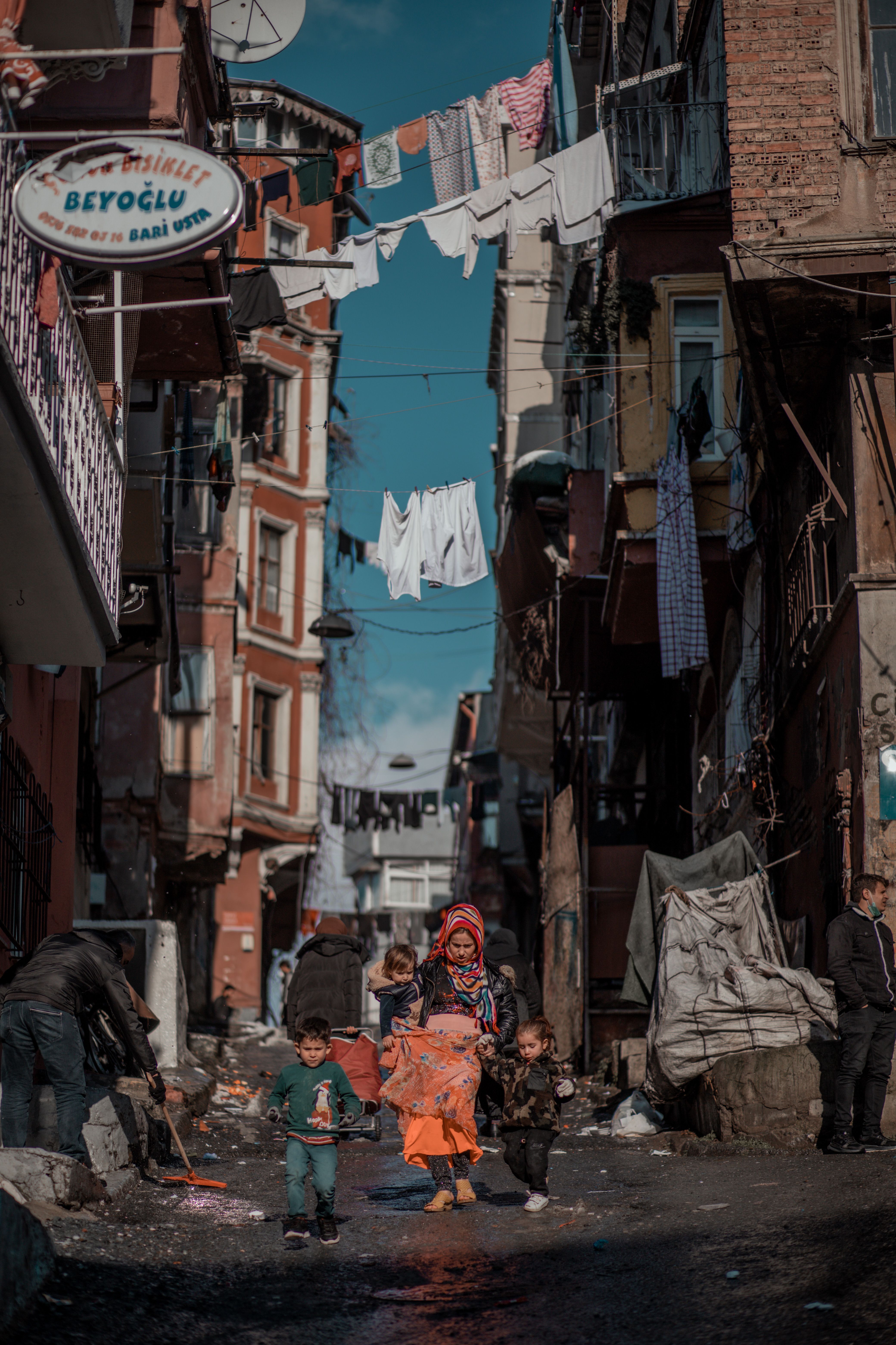 Mother with Kids on Messy Street · Free Stock Photo