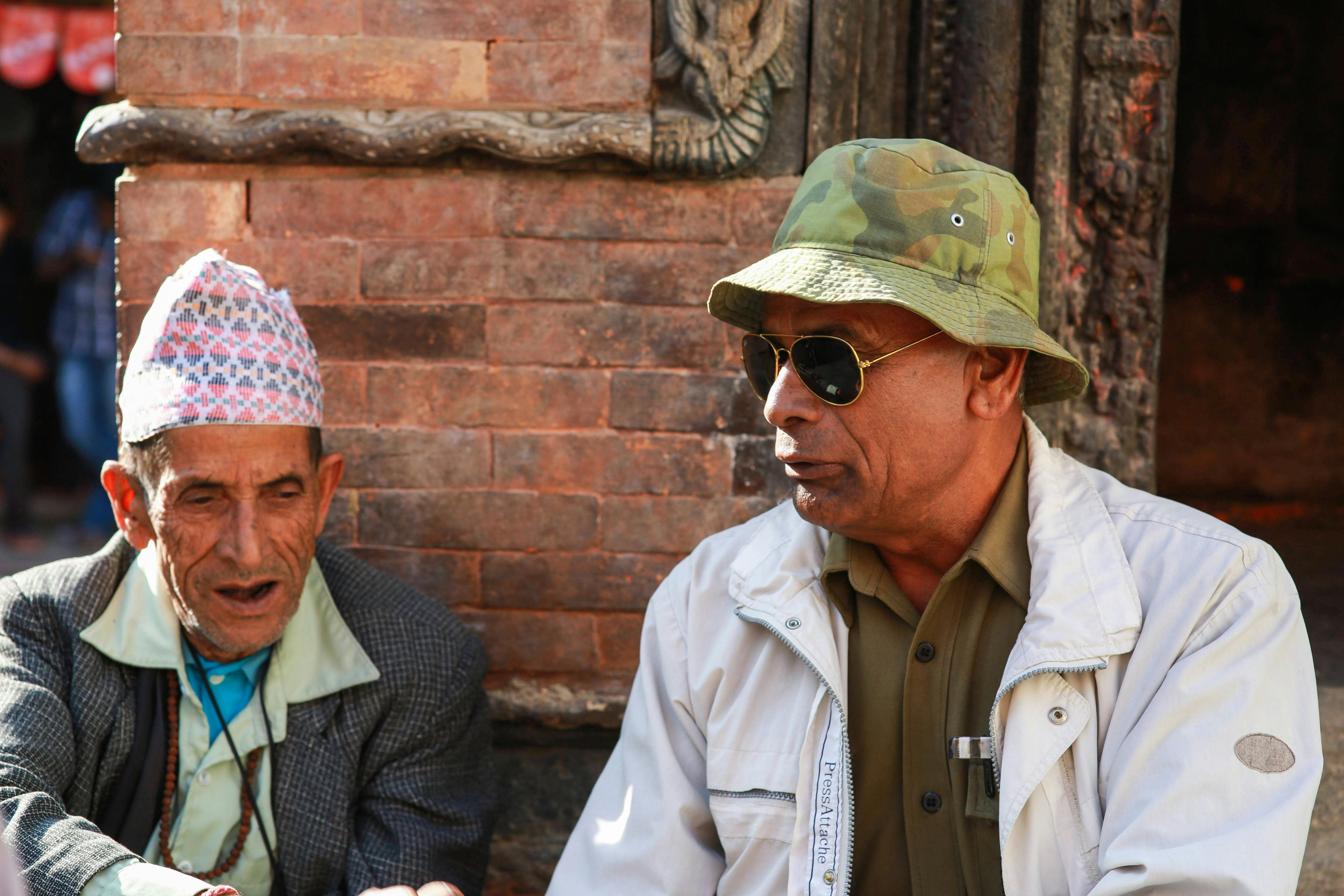 Two Men Talking in Front of a Building · Free Stock Photo