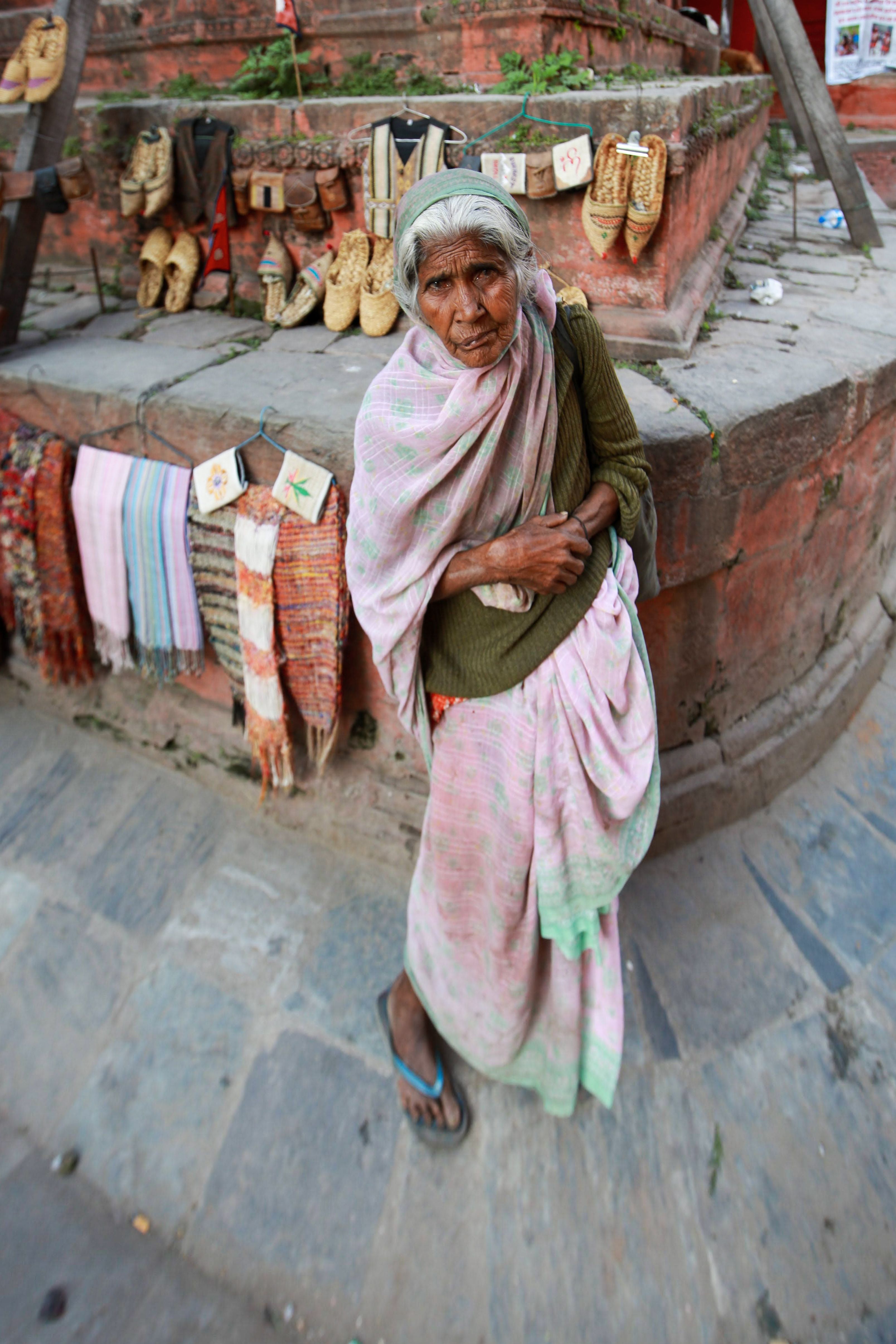 Portrait of Woman in the Street Selling Shoes · Free Stock Photo