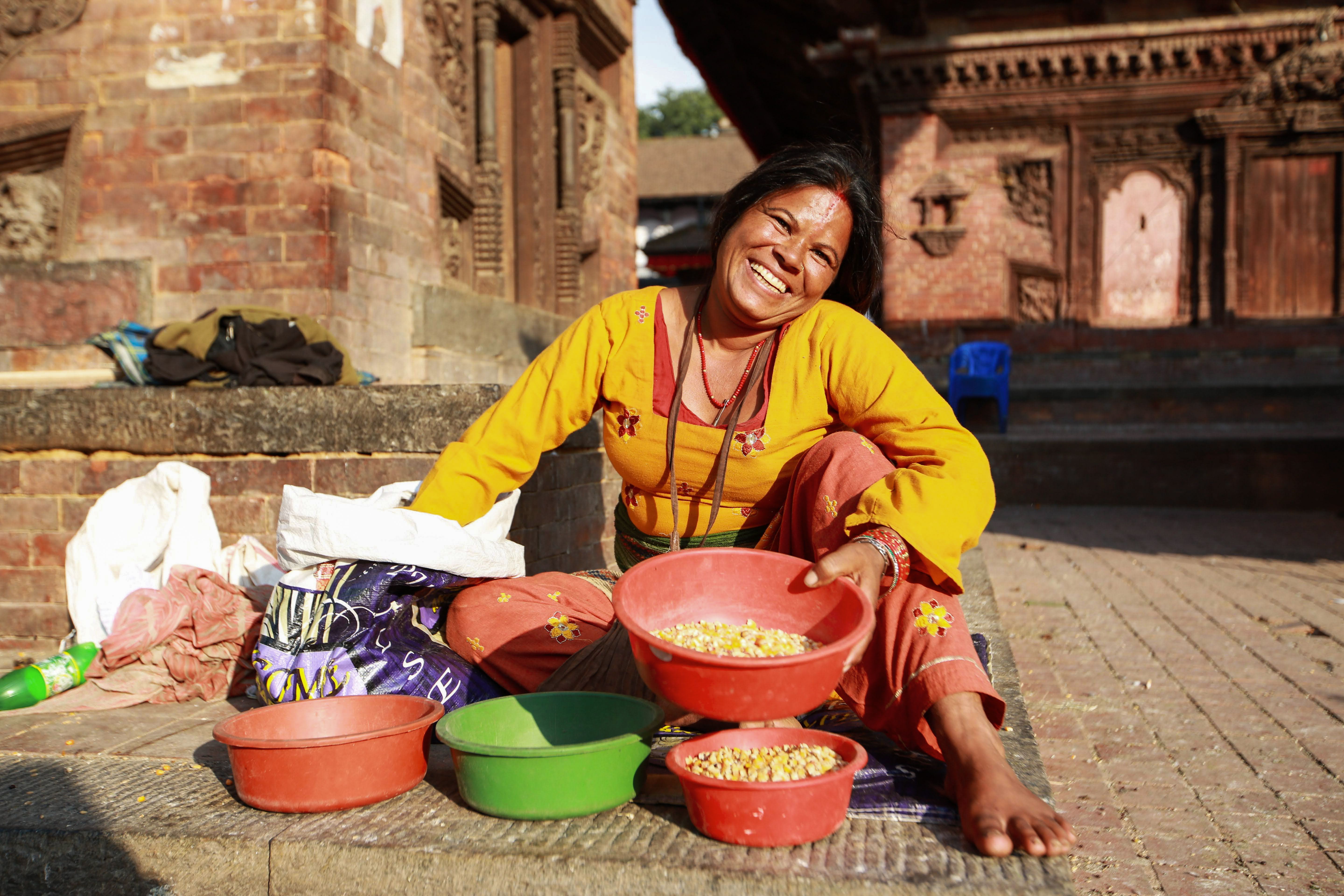 Woman Selling Graffiti Paintings on Street · Free Stock Photo