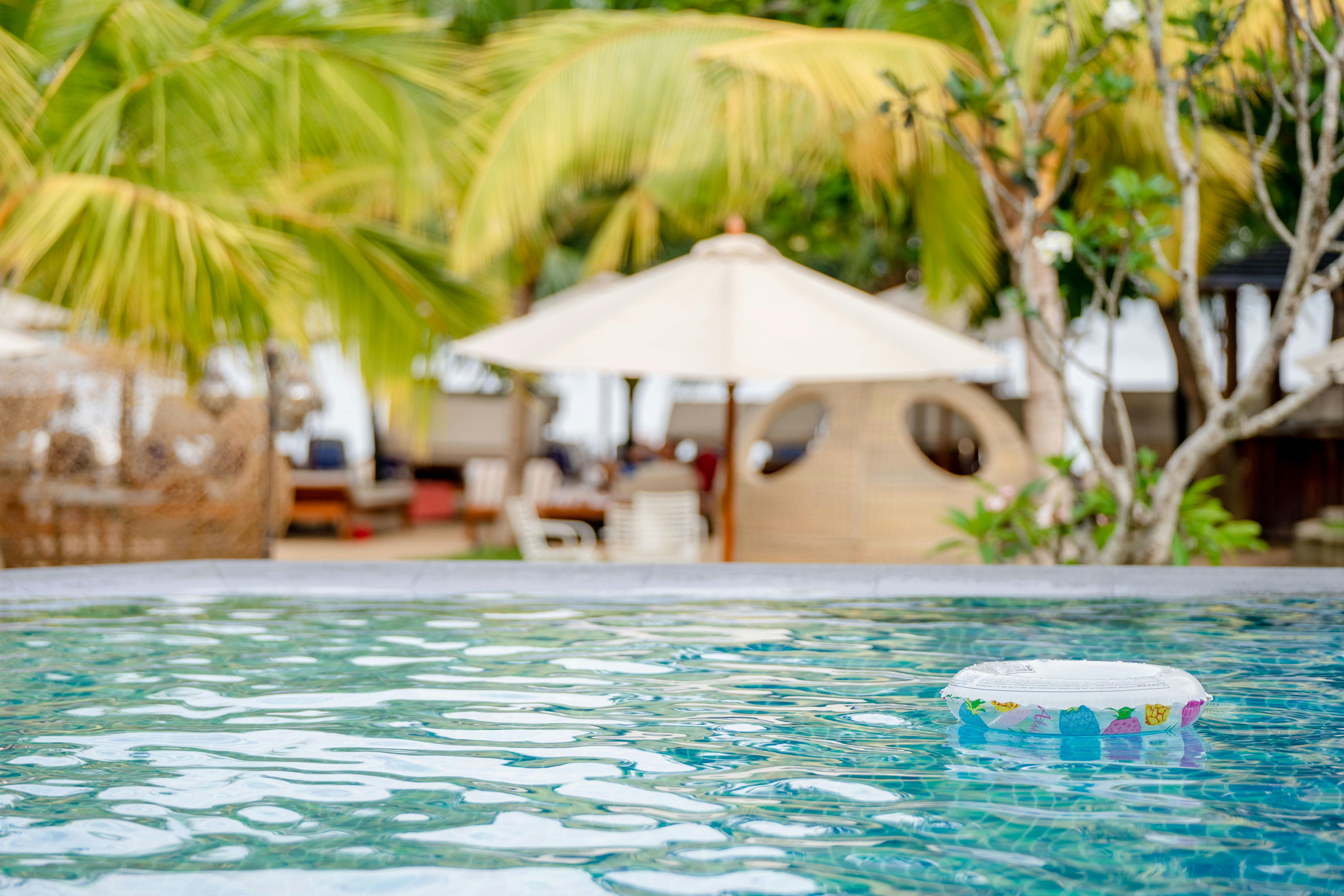 Person sitting on Poolside · Free Stock Photo