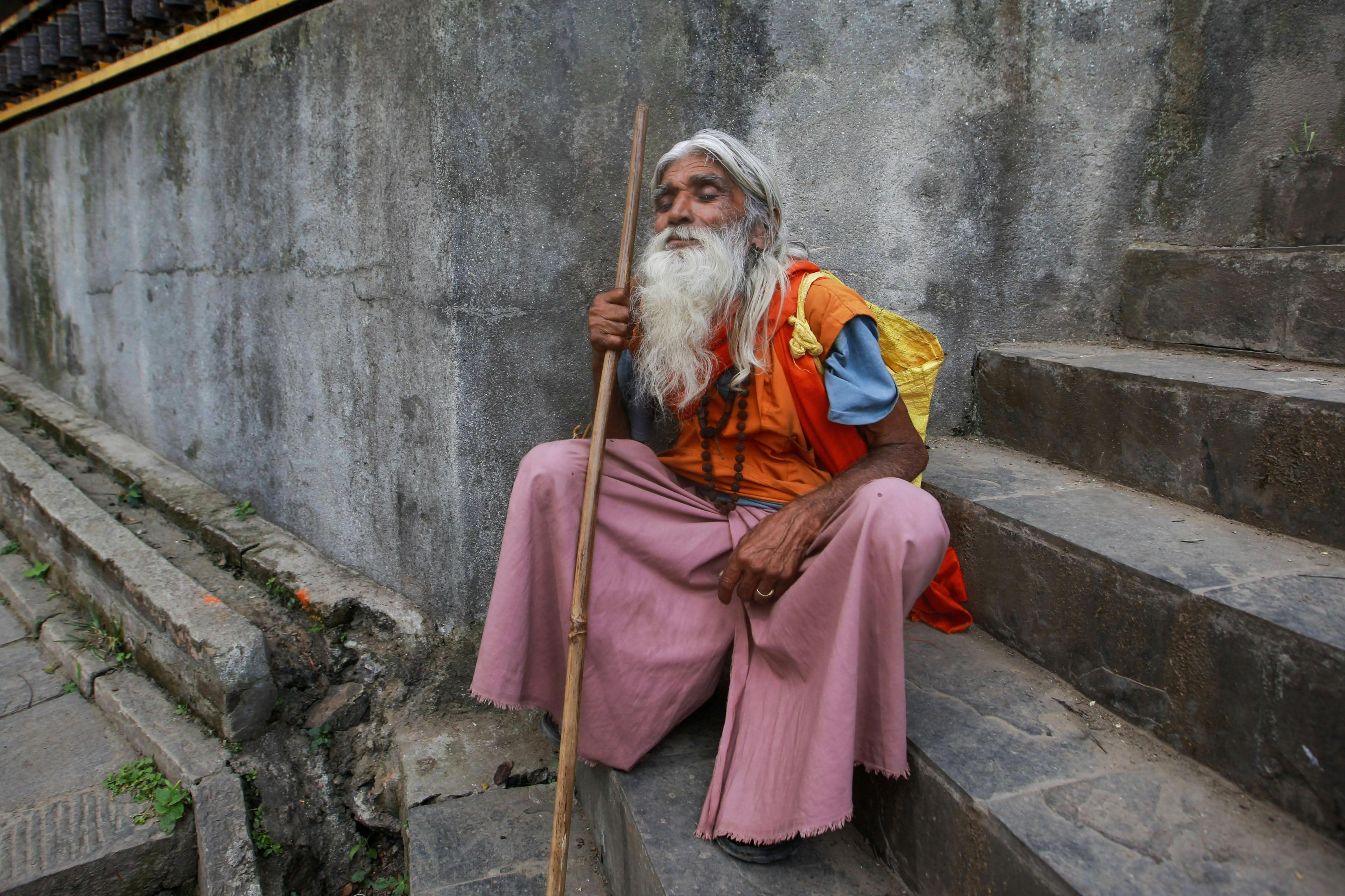 Old Man Sitting on Stairs Outdoors · Free Stock Photo