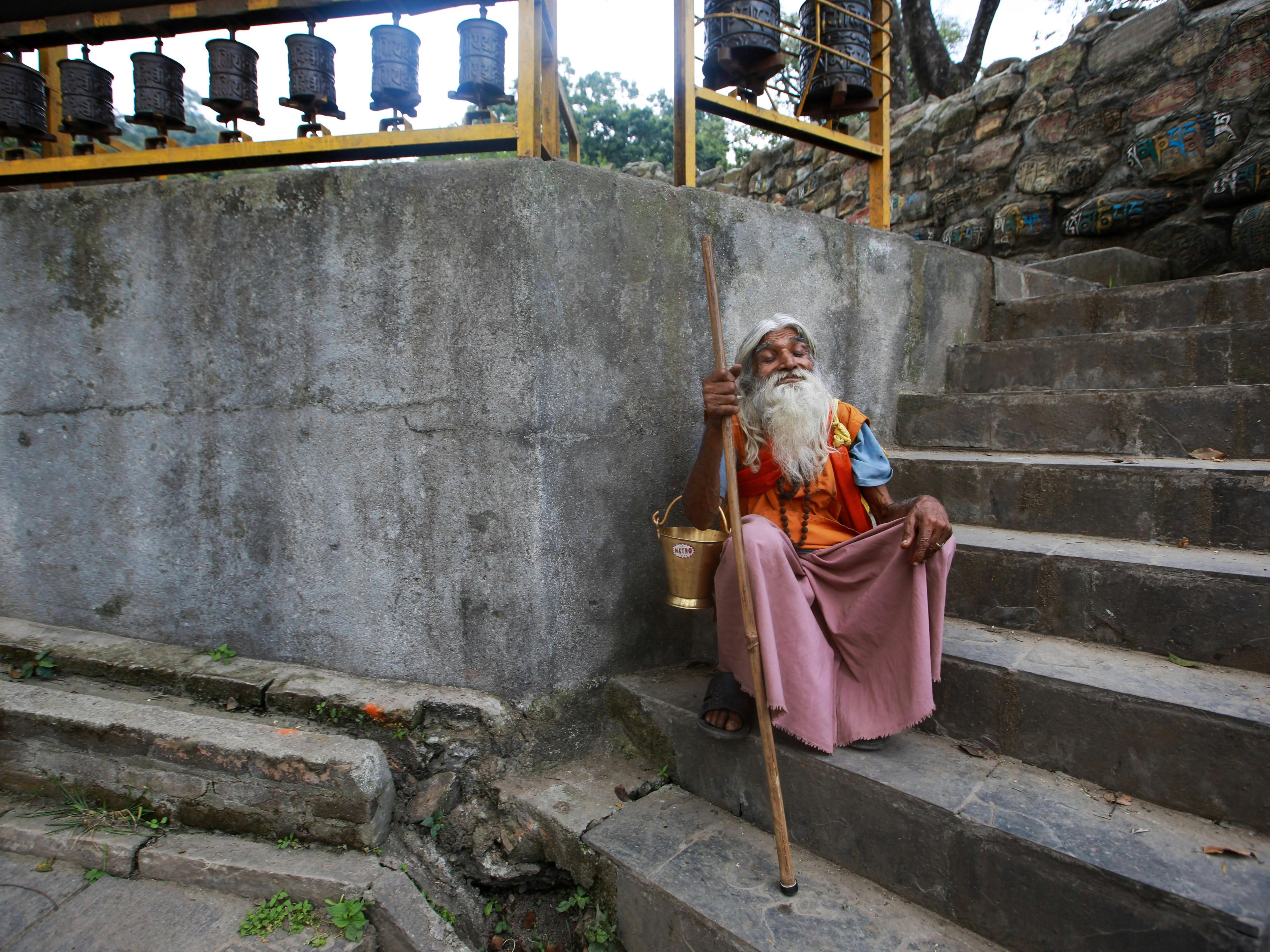 Shirtless Man Sitting on a Threshold · Free Stock Photo
