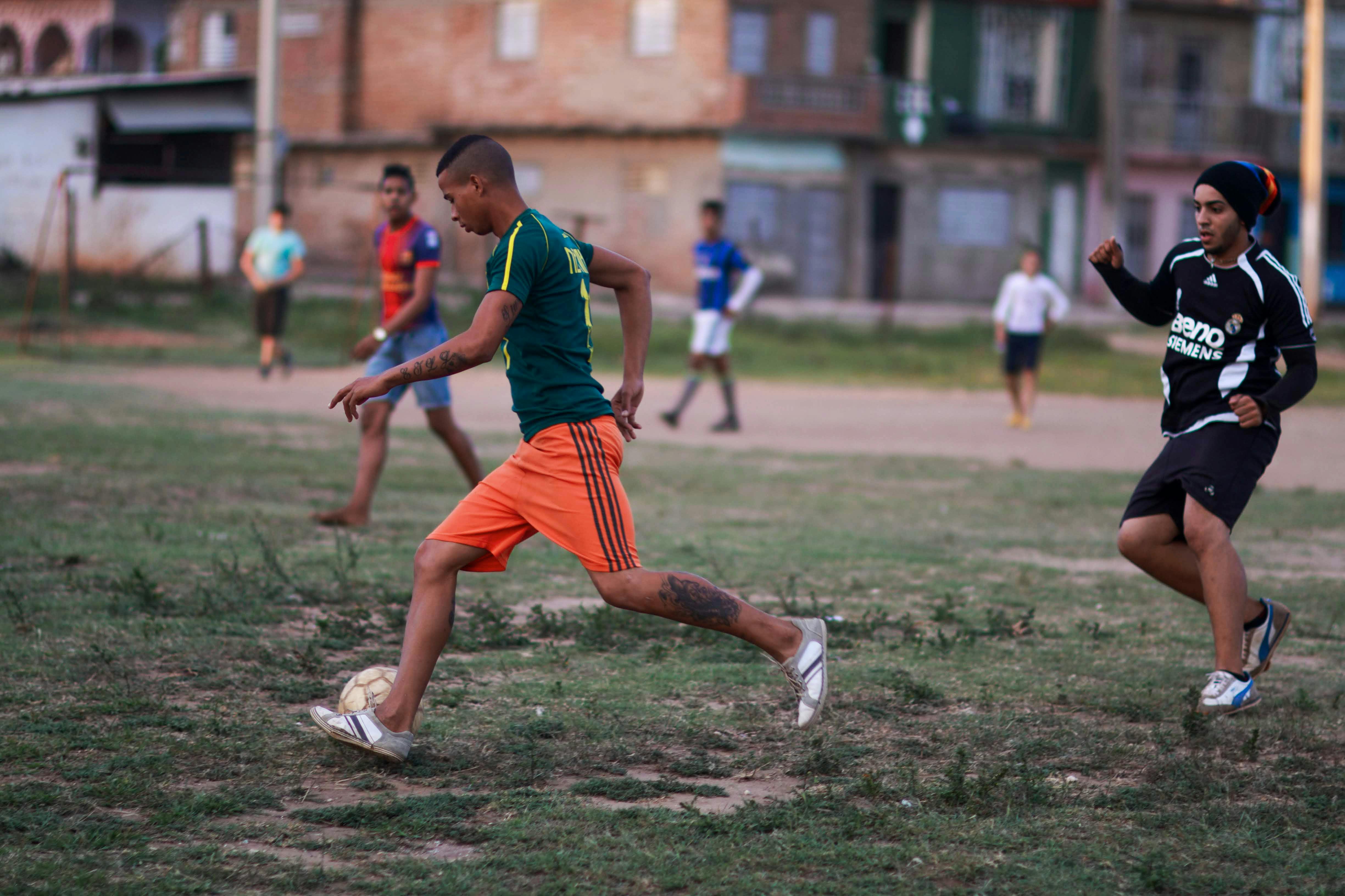 Men Playing Soccer on a Field · Free Stock Photo