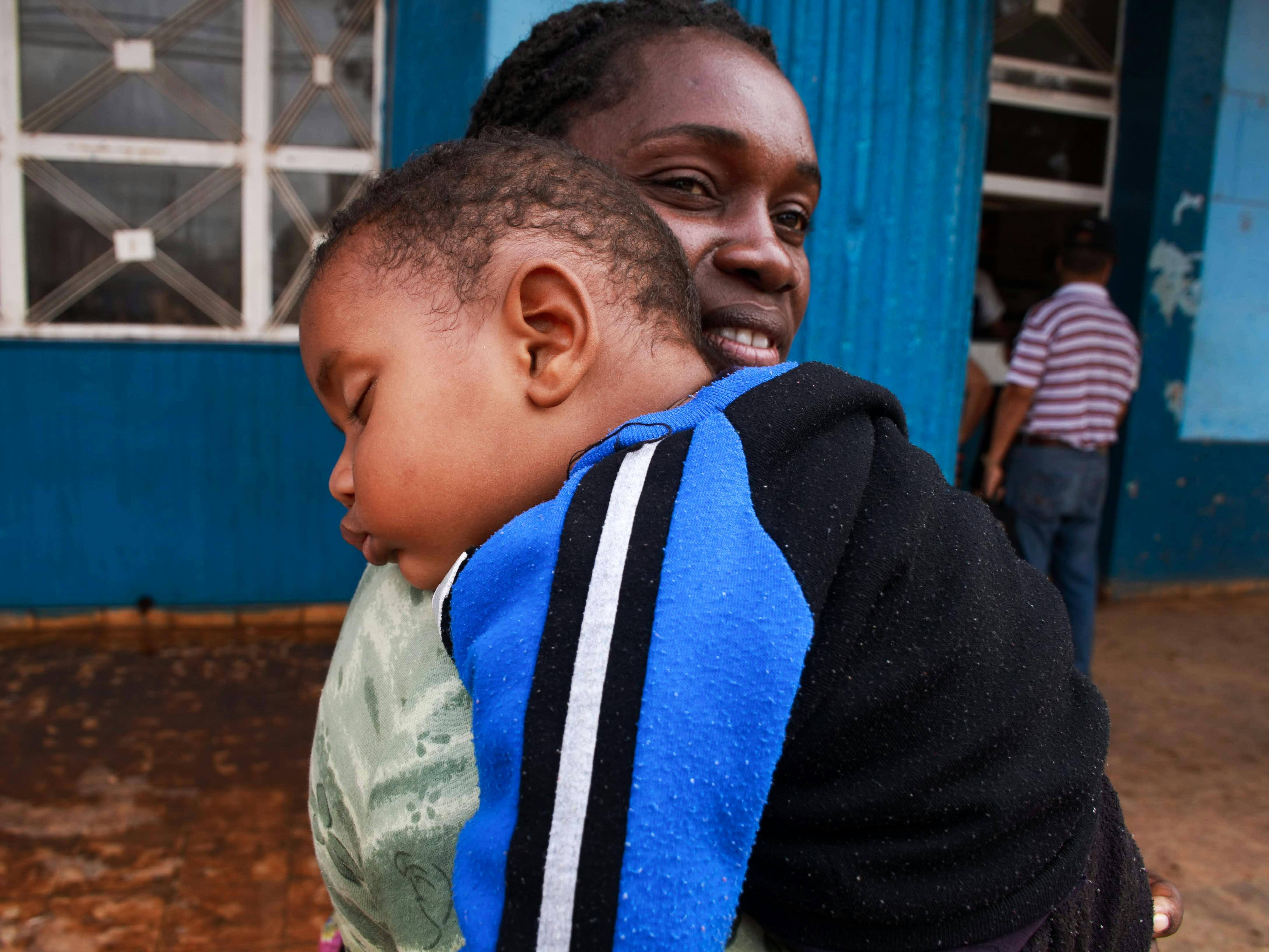 A Woman Carrying a Young Boy · Free Stock Photo