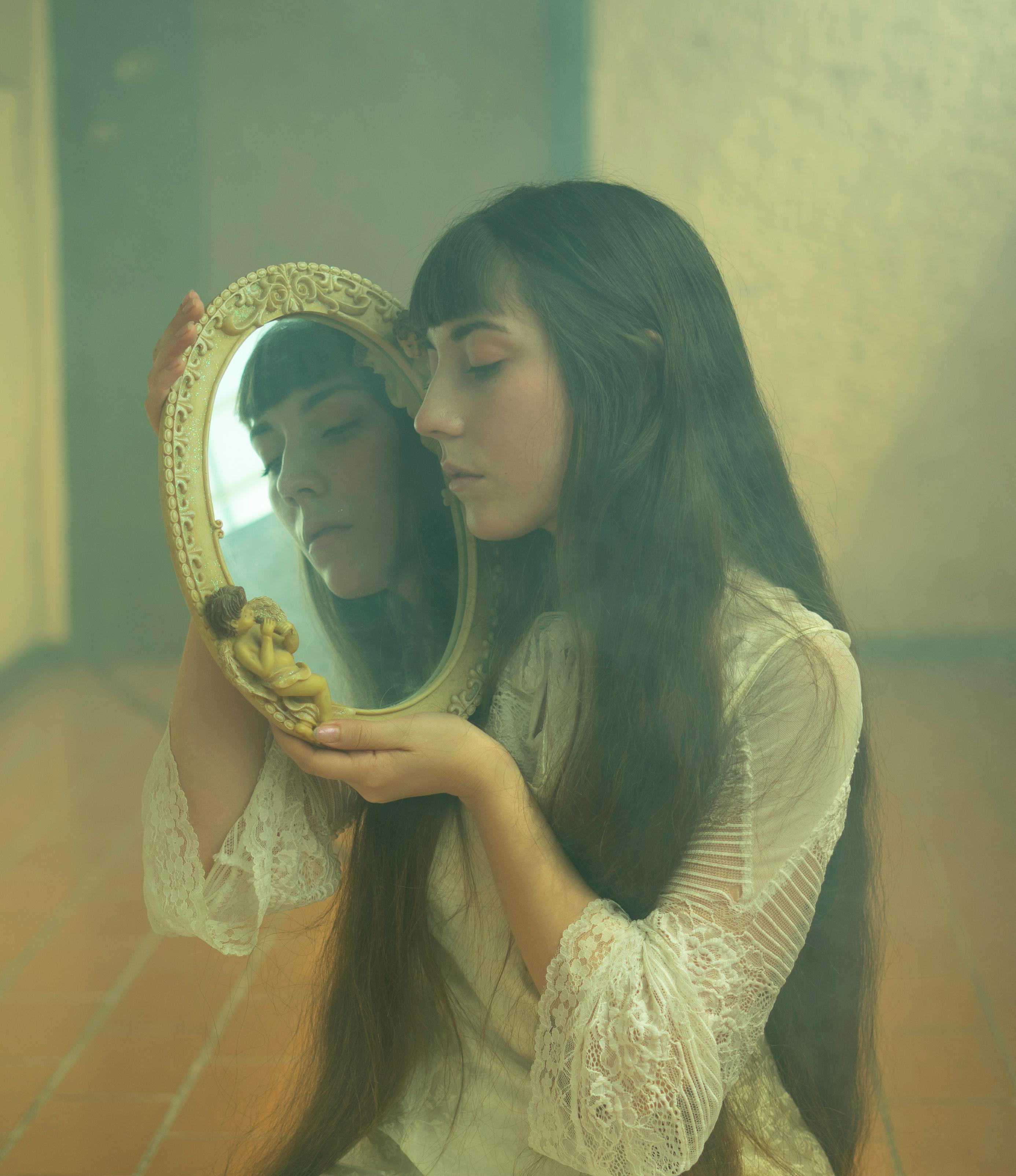 Woman with her Reflection in the Mirror · Free Stock Photo