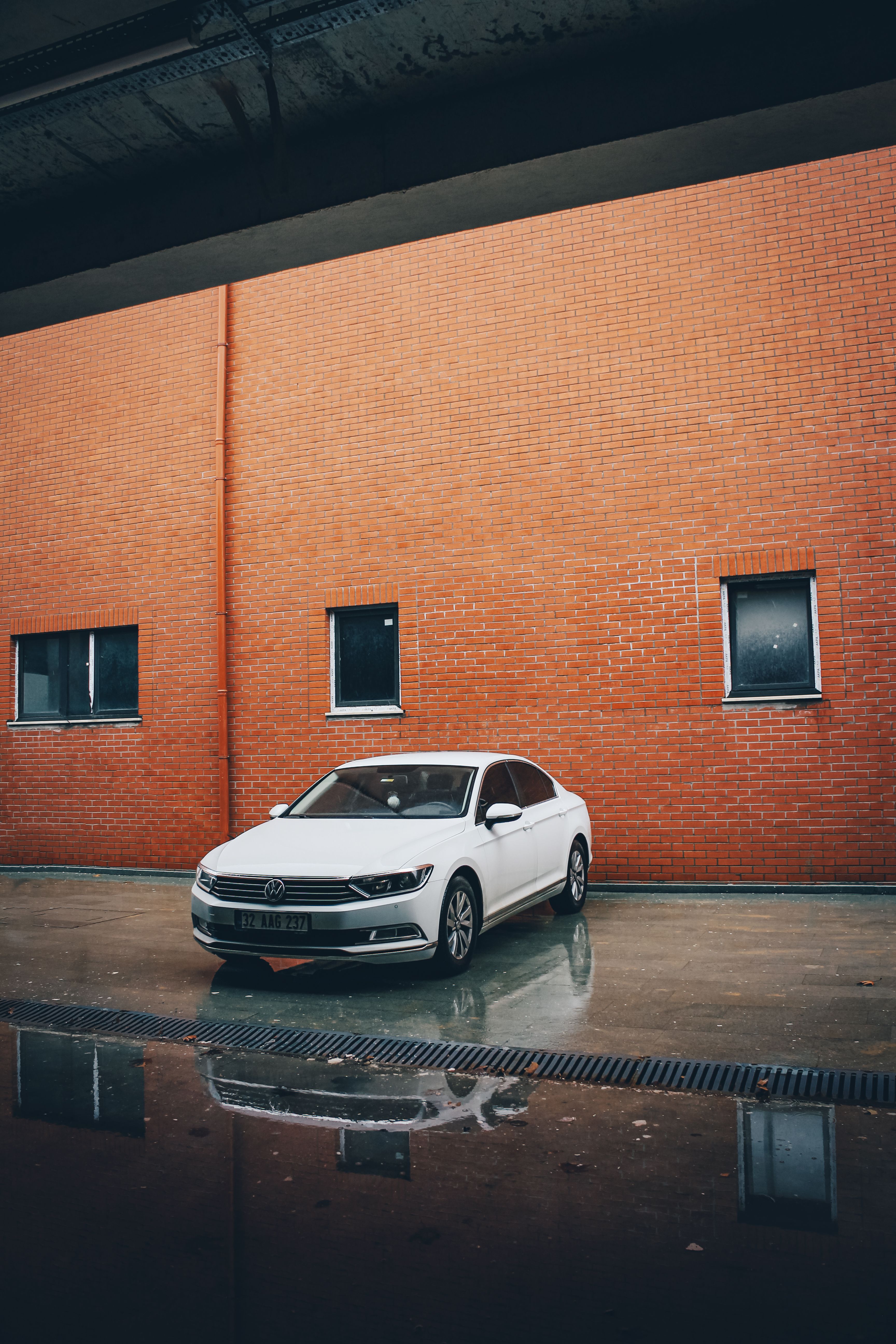 White Car Parked Beside the Brick Wall · Free Stock Photo