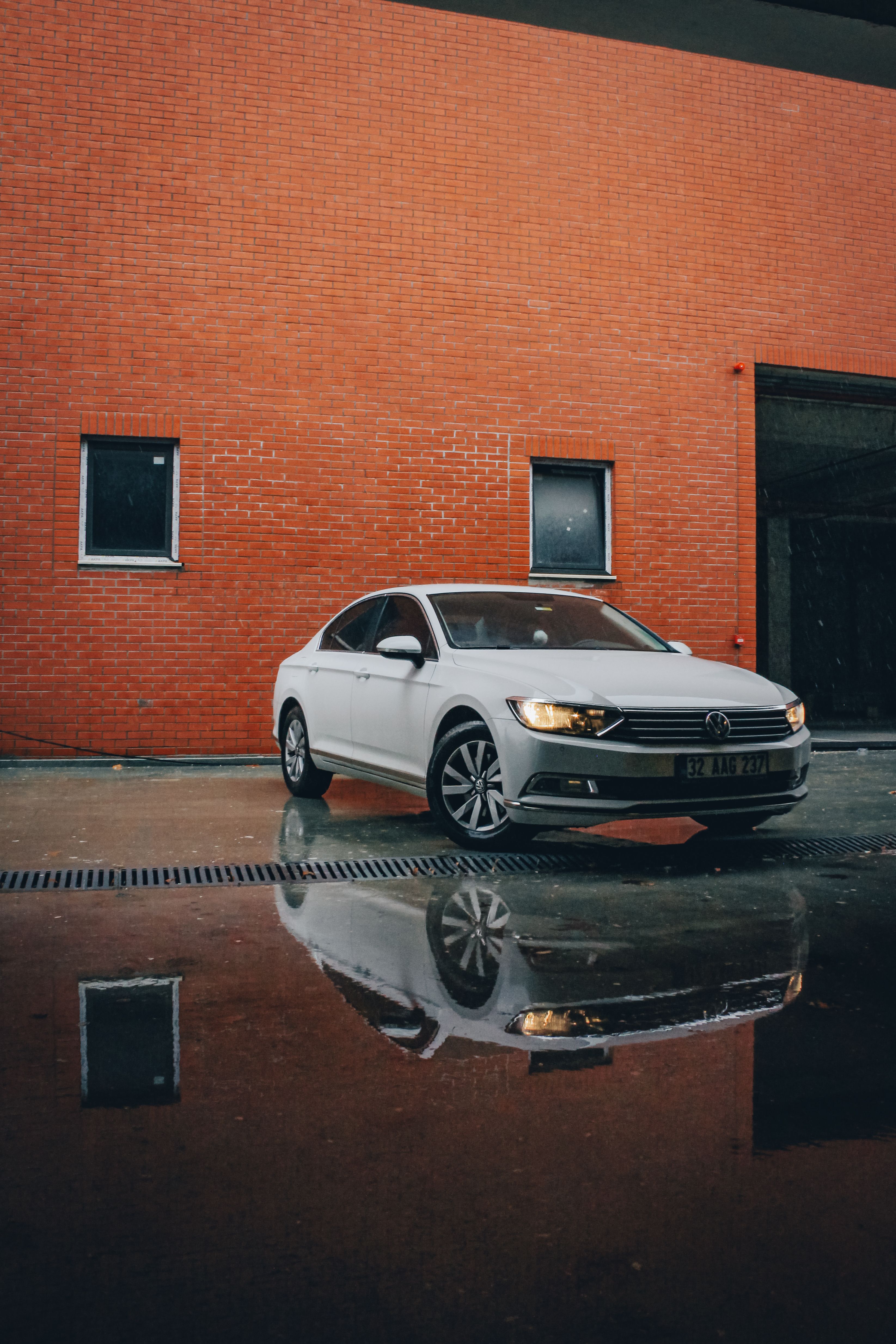 White Car Parked Beside the Brick Wall · Free Stock Photo