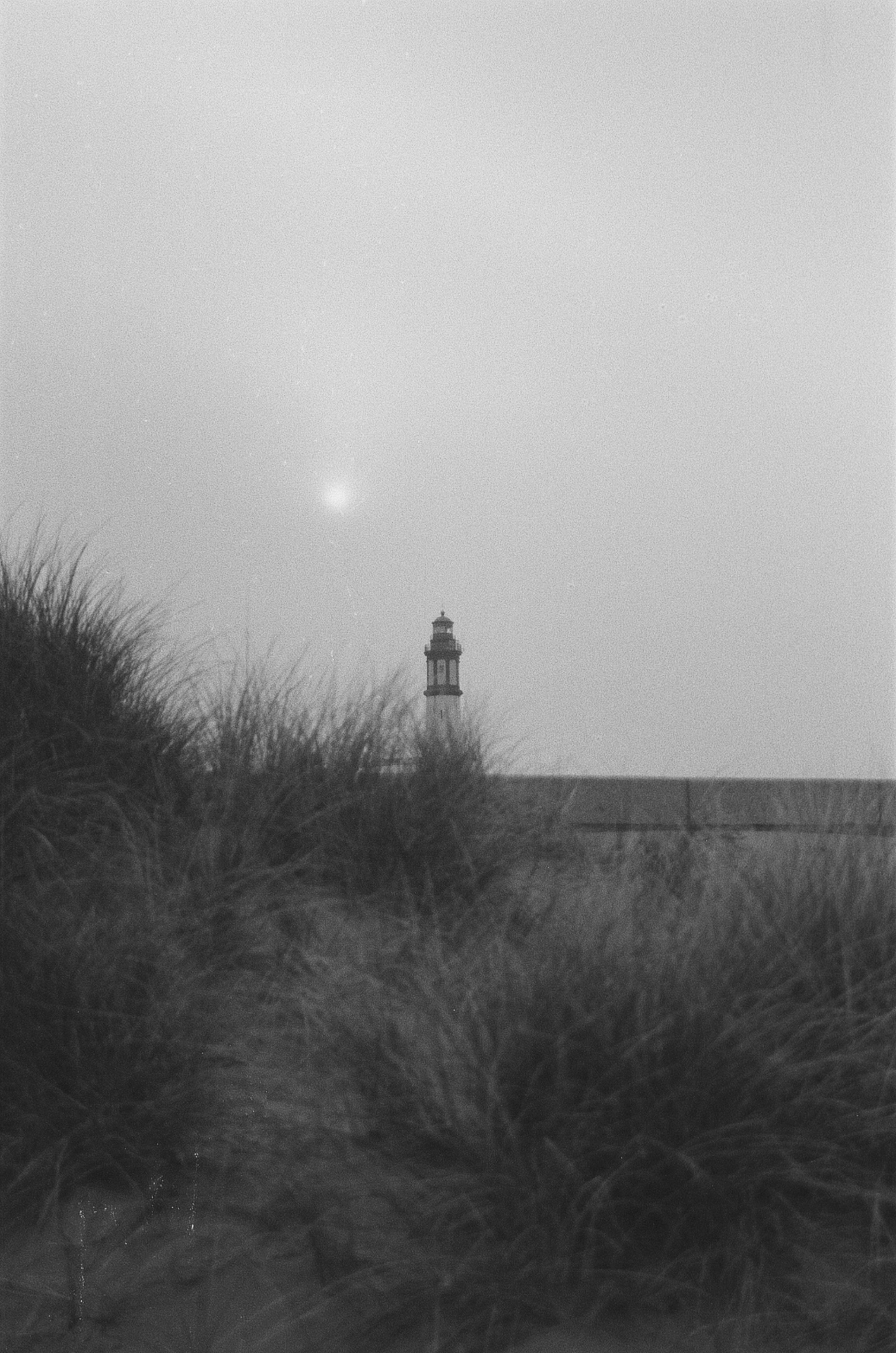 Grayscale Photography of Lighthouse on Hill · Free Stock Photo