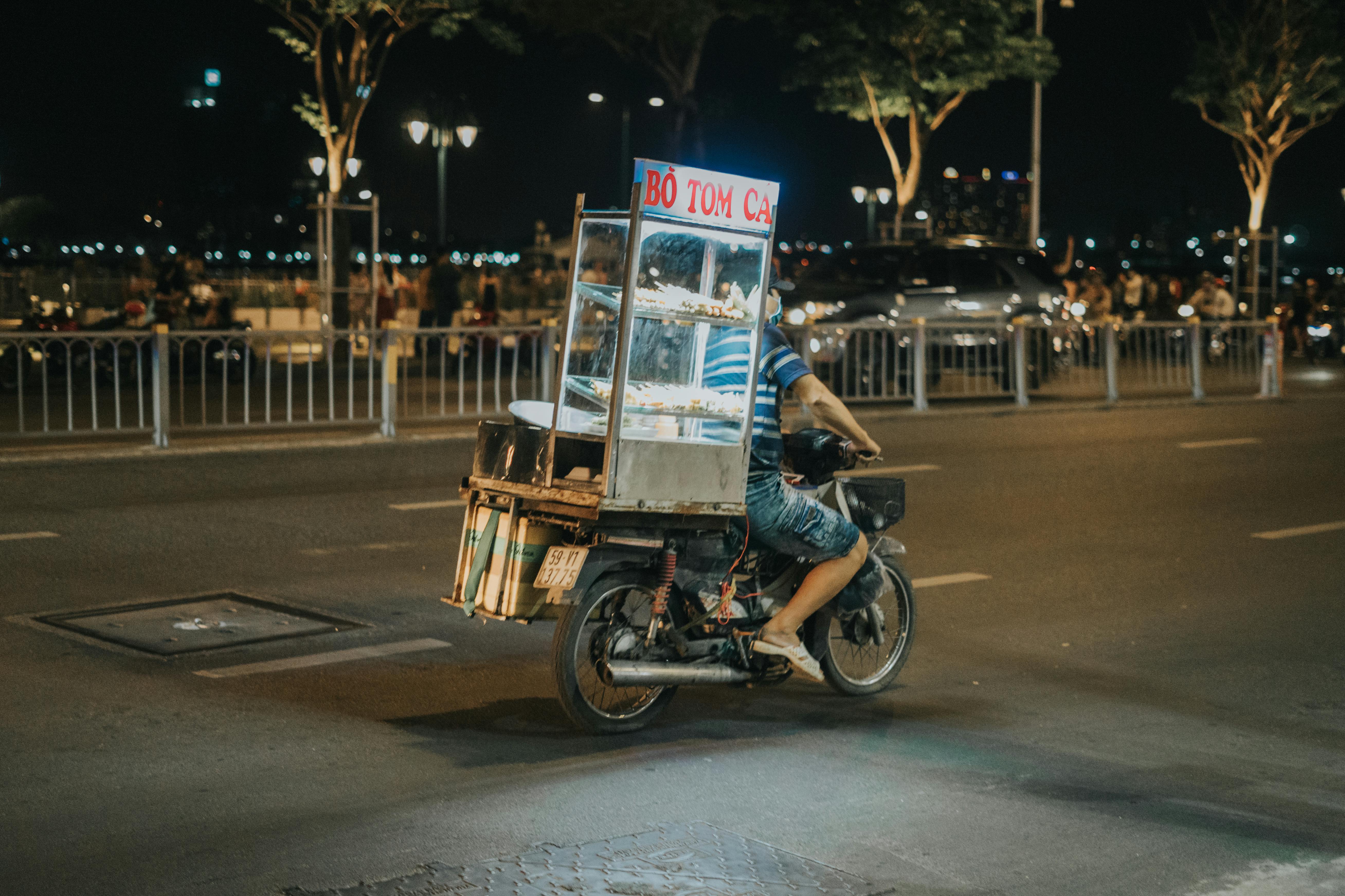 Street Vendor Riding a Motorcycle · Free Stock Photo