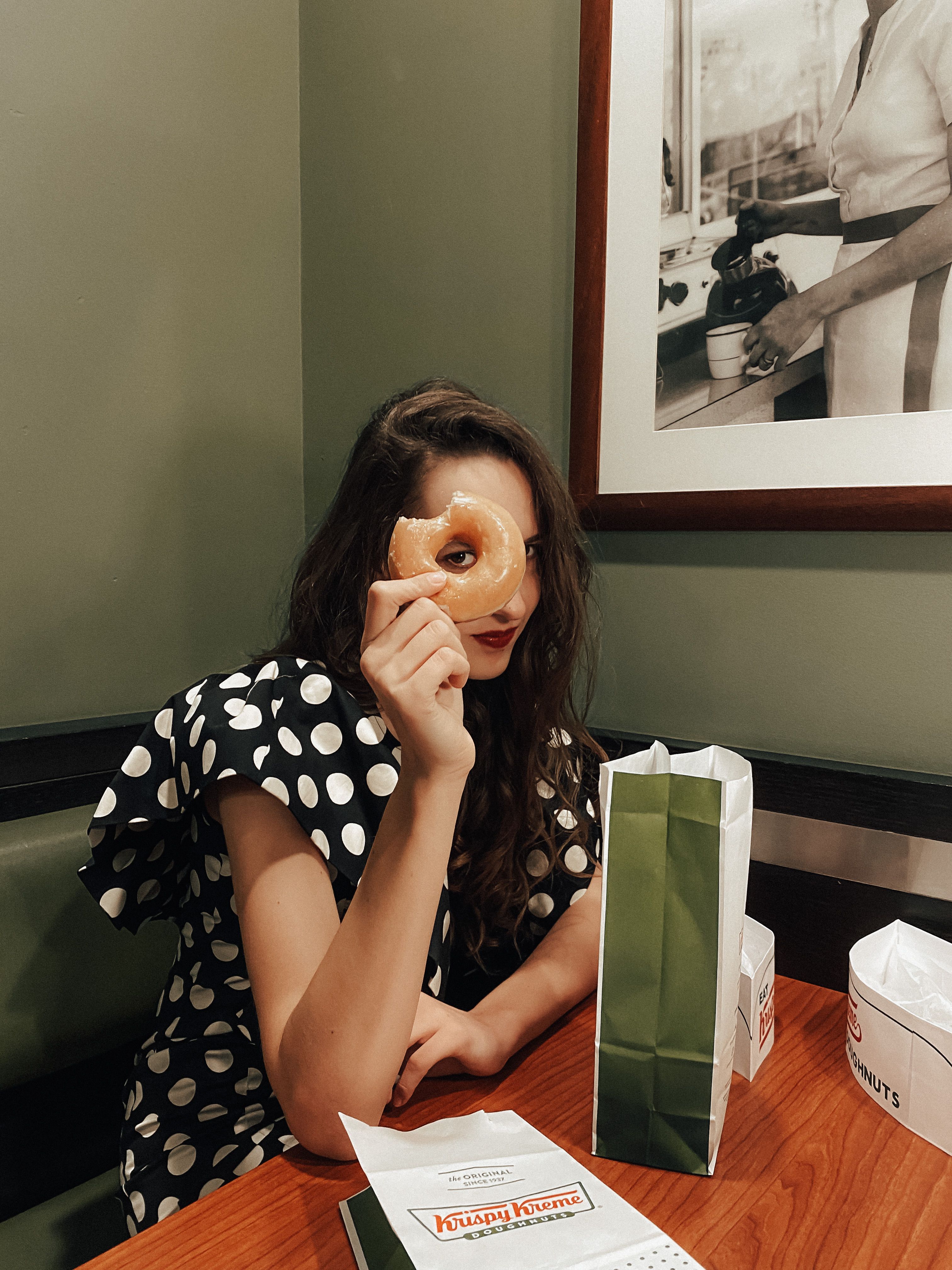 Girl Eating and Looking Through Donut · Free Stock Photo
