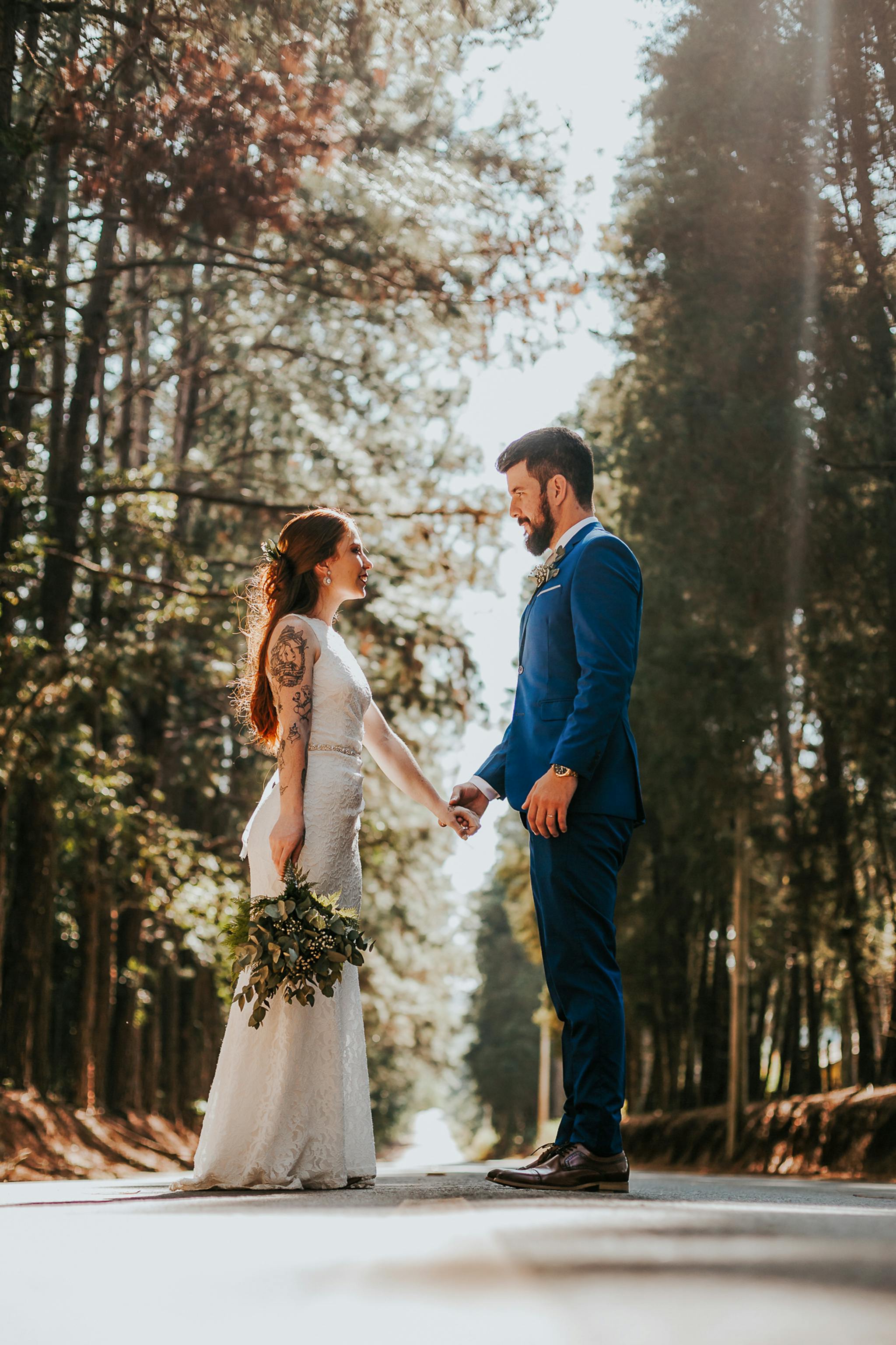 Tattooed Arm of Unrecognizable Bride Clinging to Groom · Free Stock Photo
