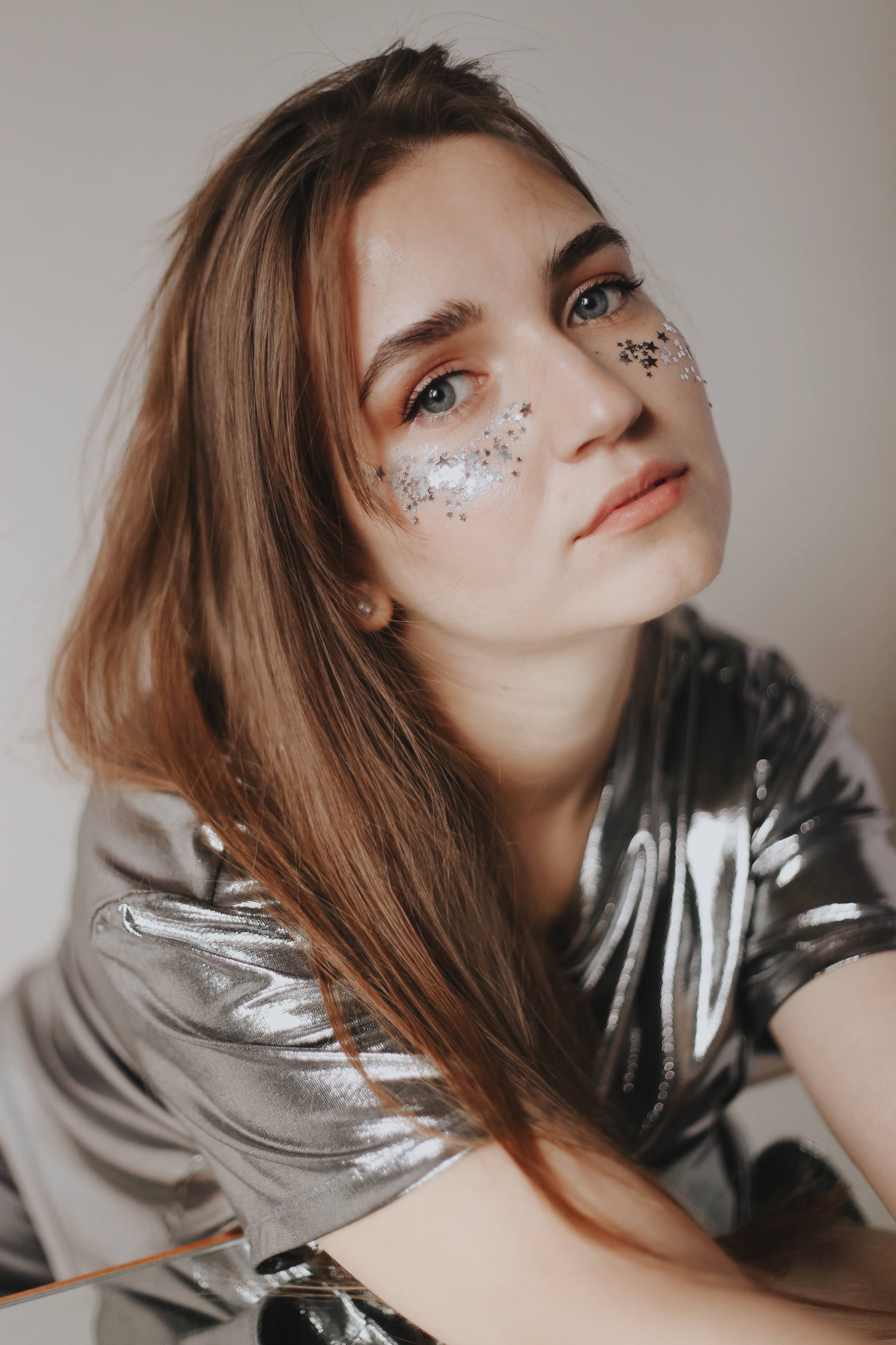 Young Woman with Silver Star Stickers on her Face · Free Stock Photo