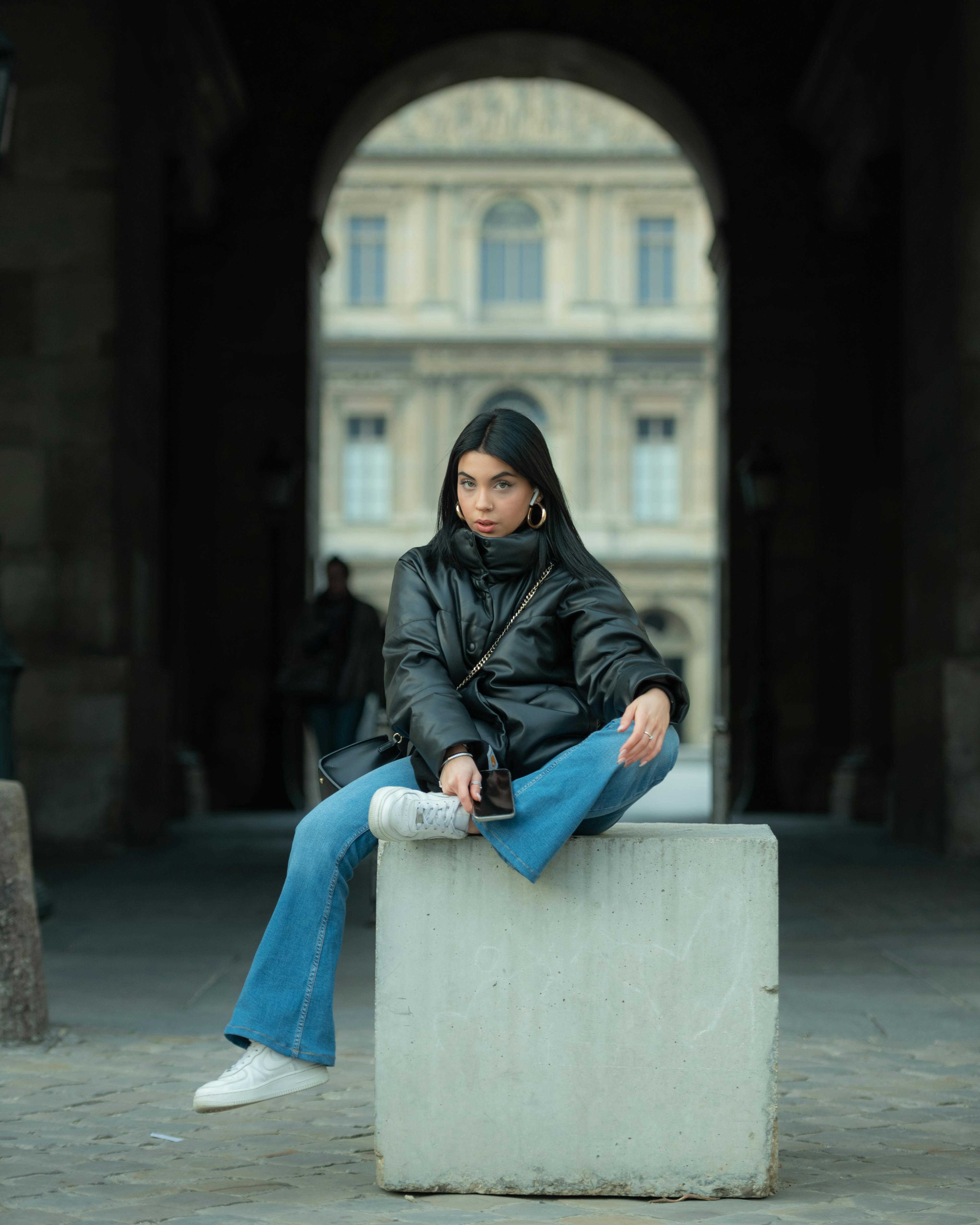 Man in Black Leather Jacket Sitting on a Metal Ladder · Free Stock Photo