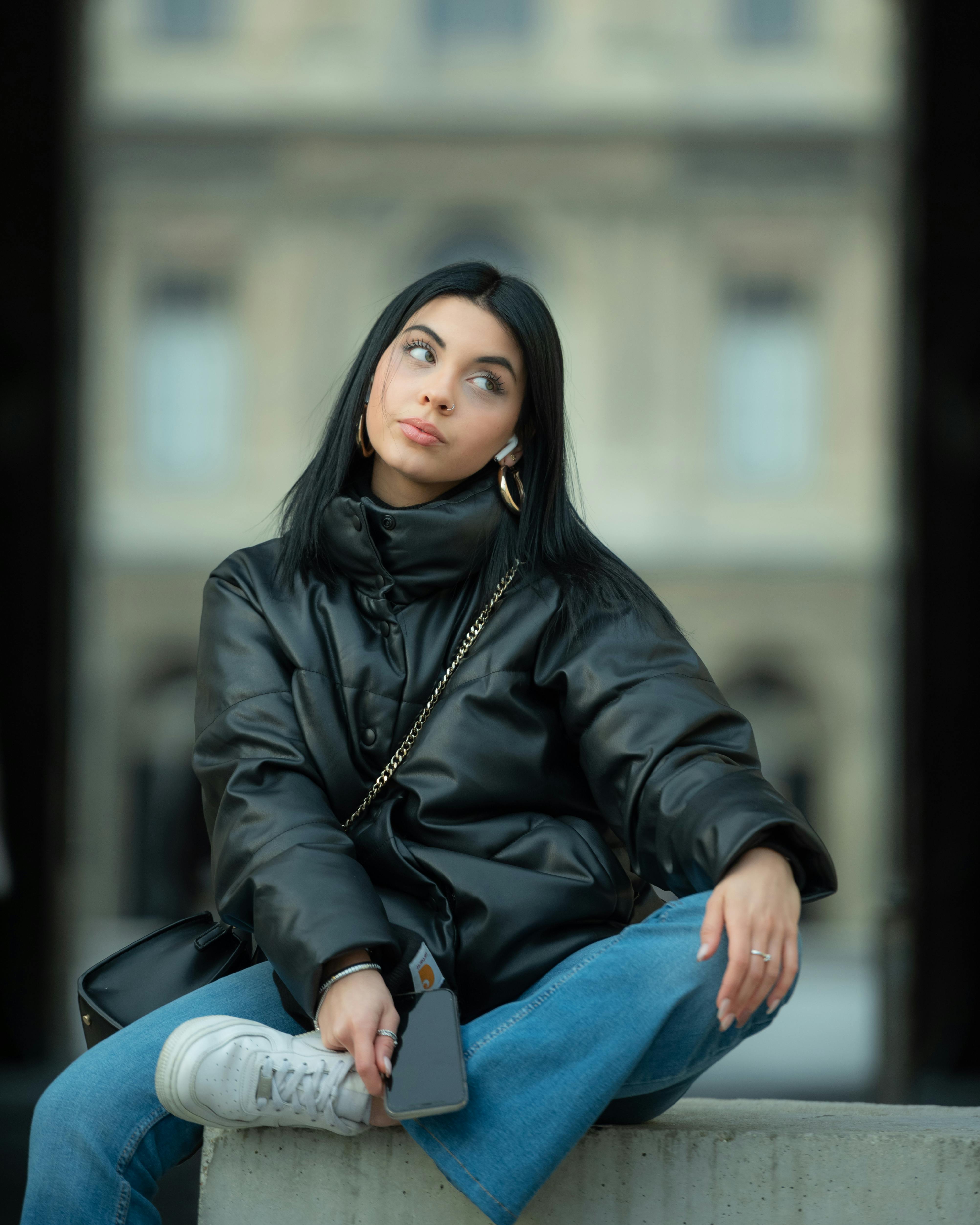 Man in Black Leather Jacket Sitting on a Metal Ladder · Free Stock Photo