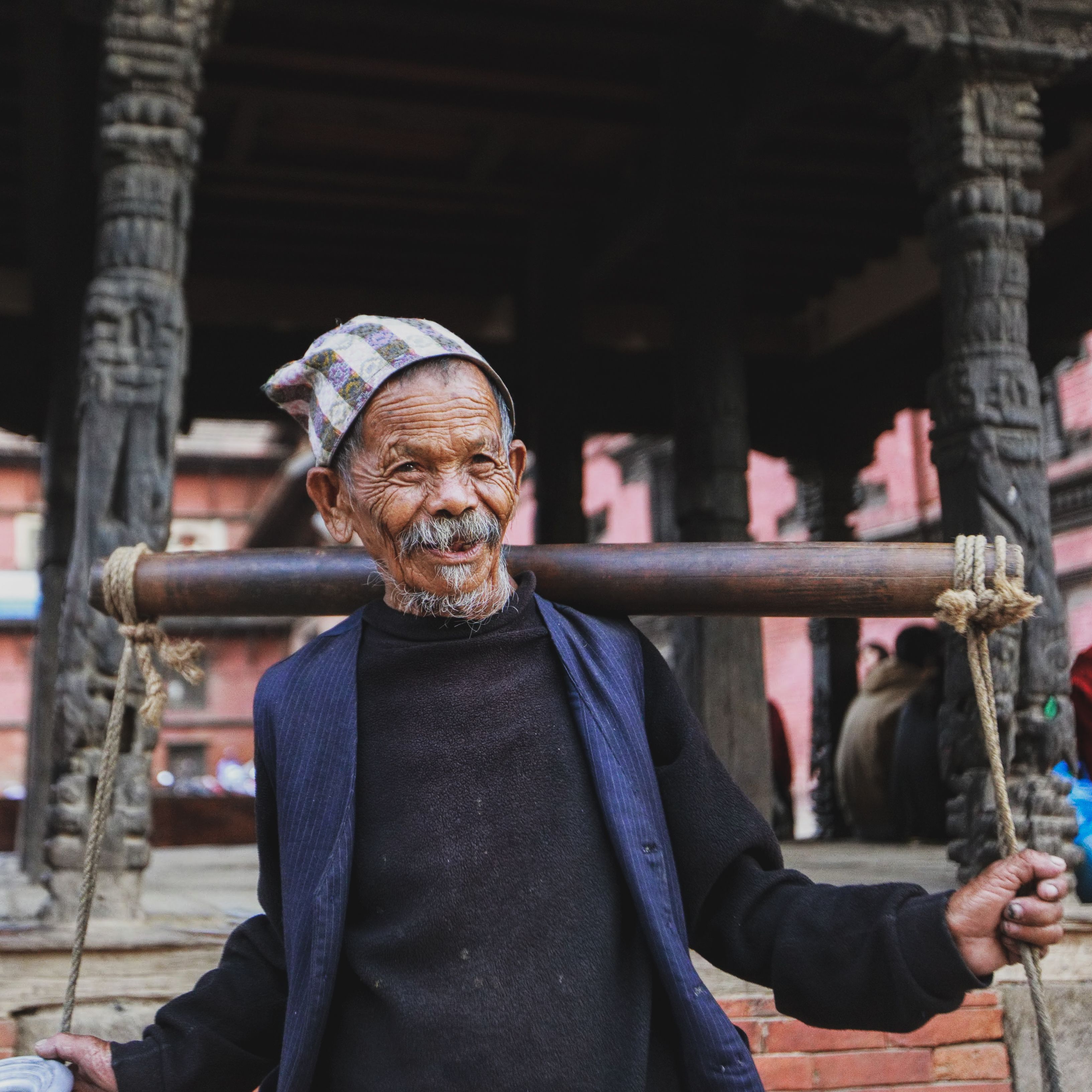 Old Man Carrying a Heavy Bar On His Back · Free Stock Photo