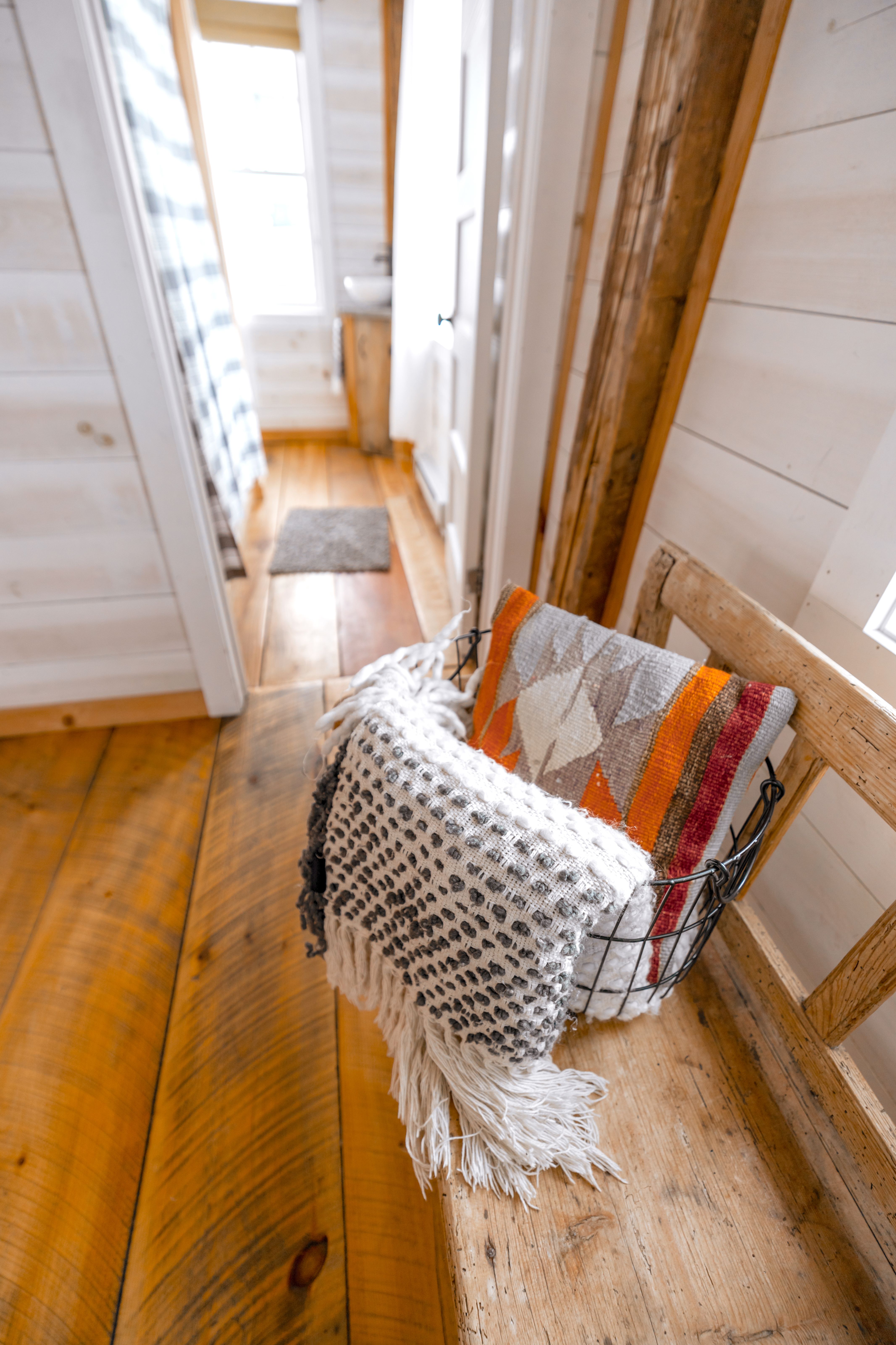 A Throw Pillow and a Blanket on a Wooden Bench · Free Stock Photo