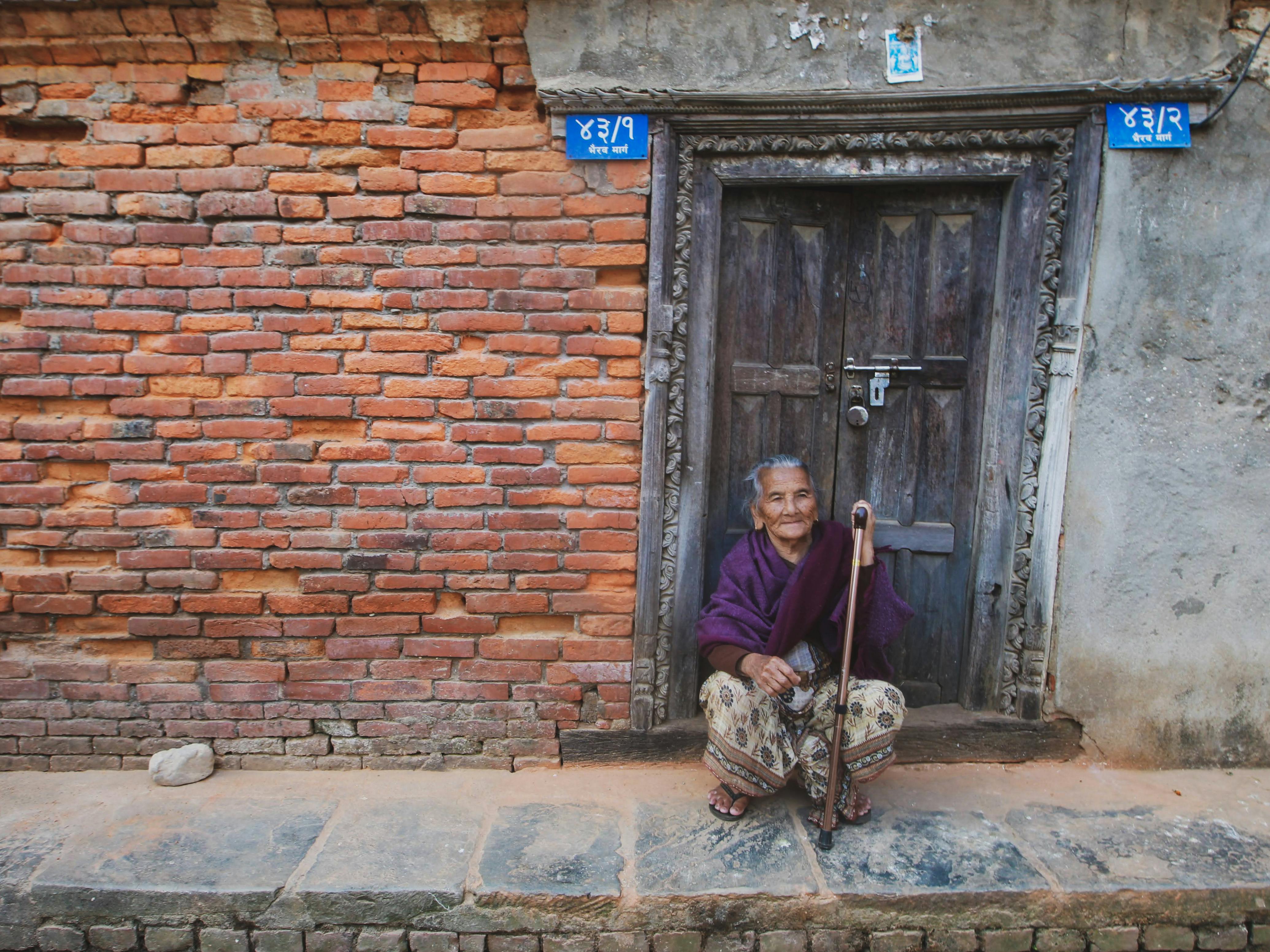 Elderly Woman Behind Metal Bars · Free Stock Photo