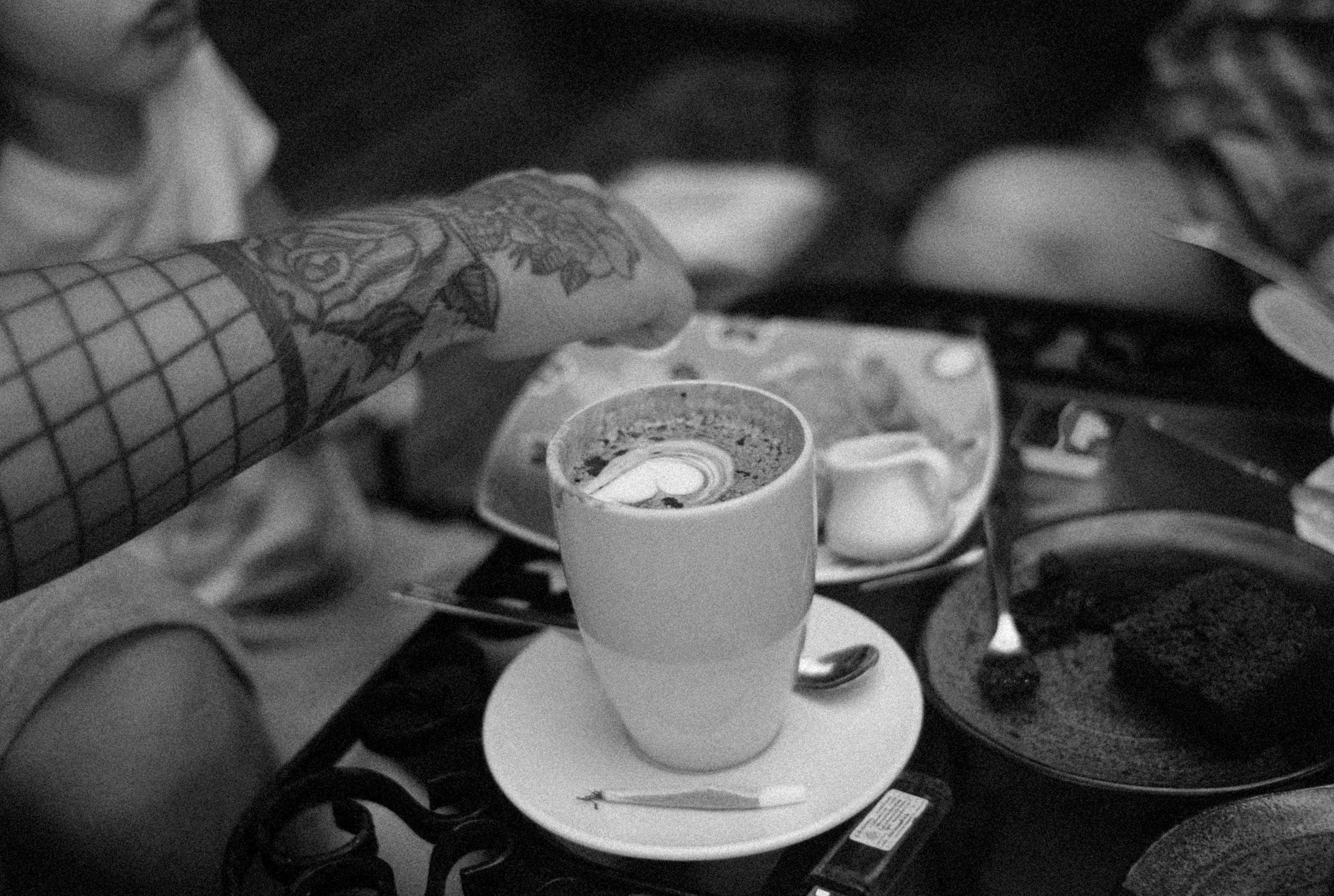 A Grayscale of Men Drinking Cups of Coffee · Free Stock Photo