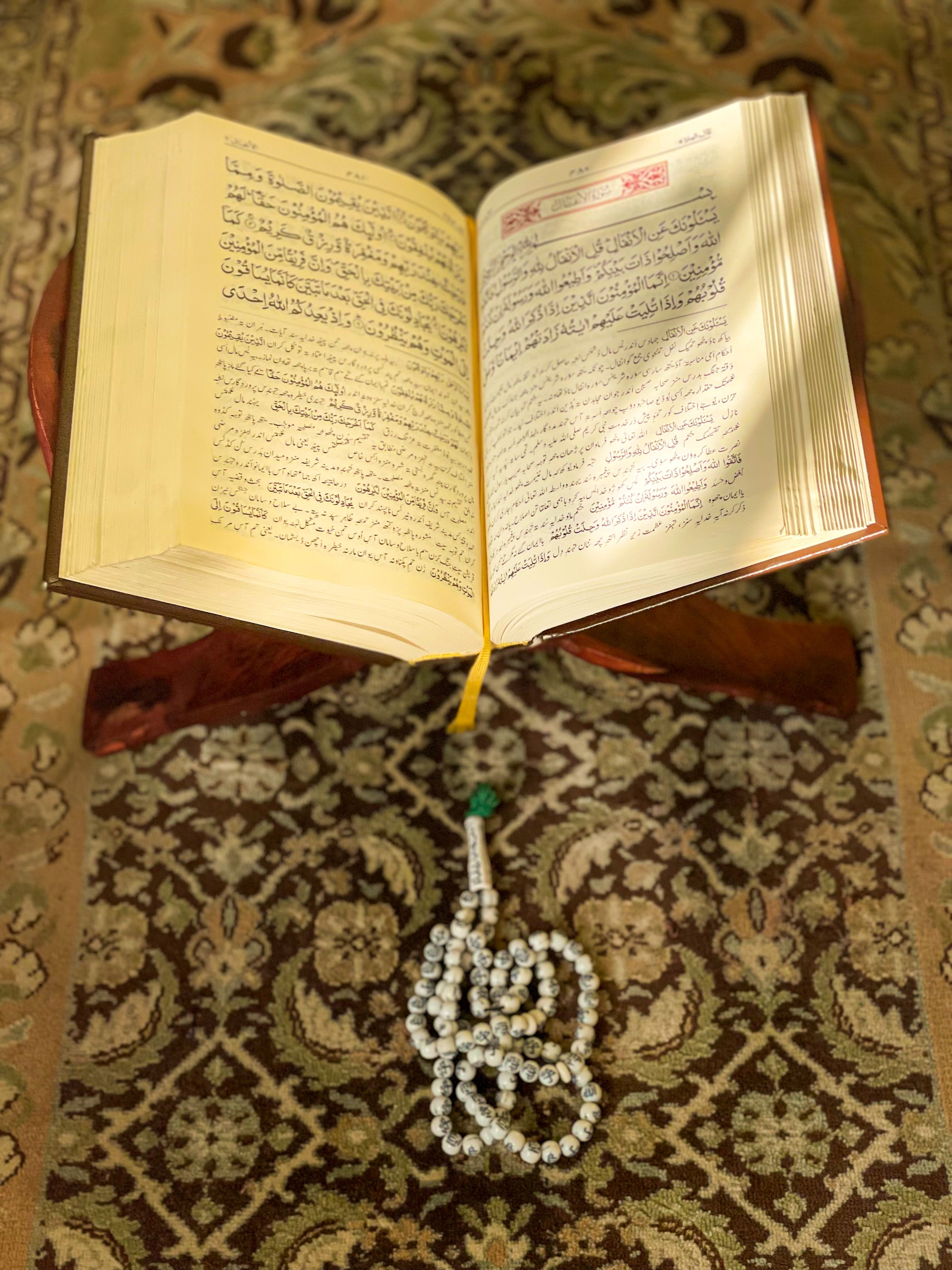 An Open Koran on a Wooden Table · Free Stock Photo