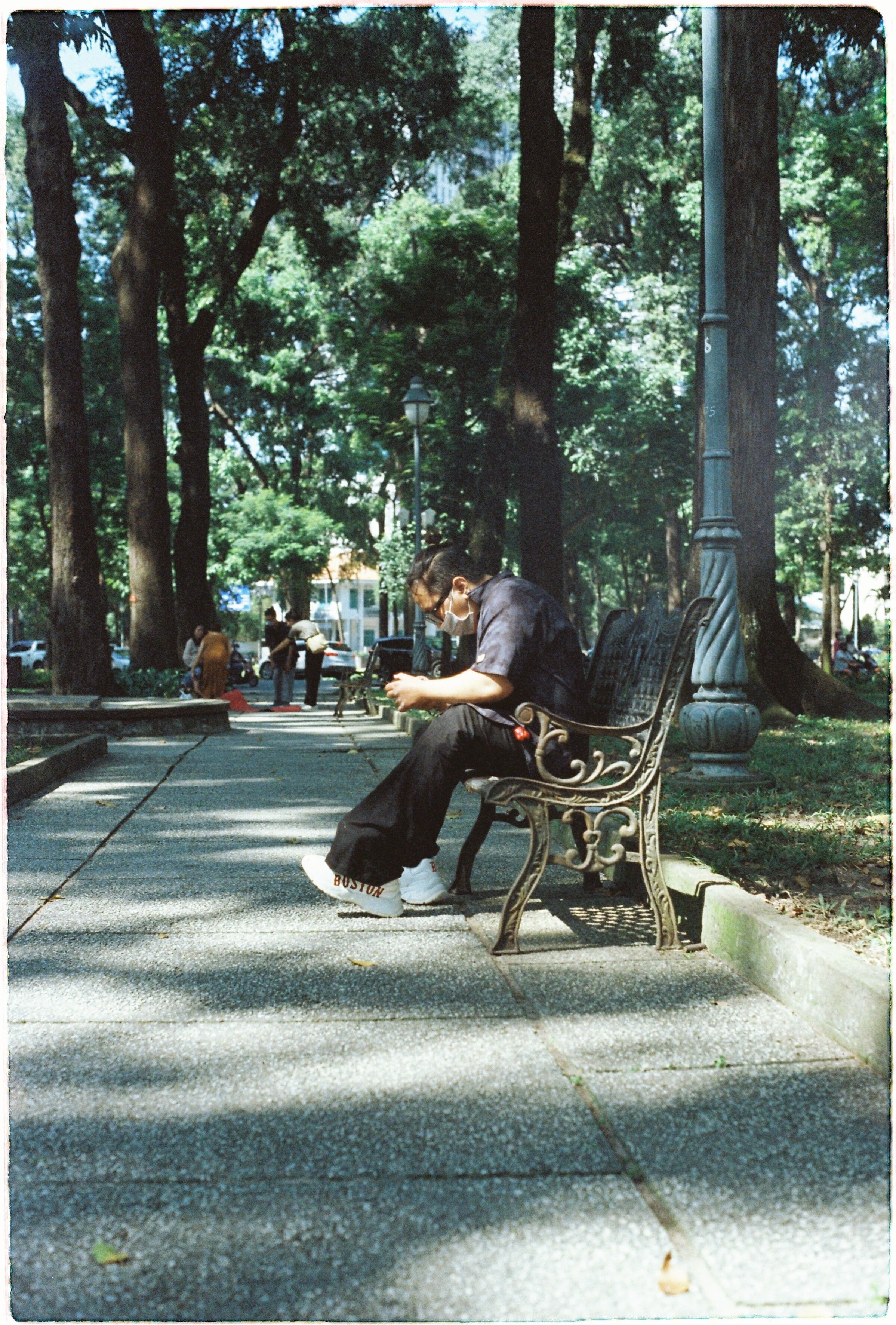Side View Photo of Man Sitting on Park Bench · Free Stock Photo