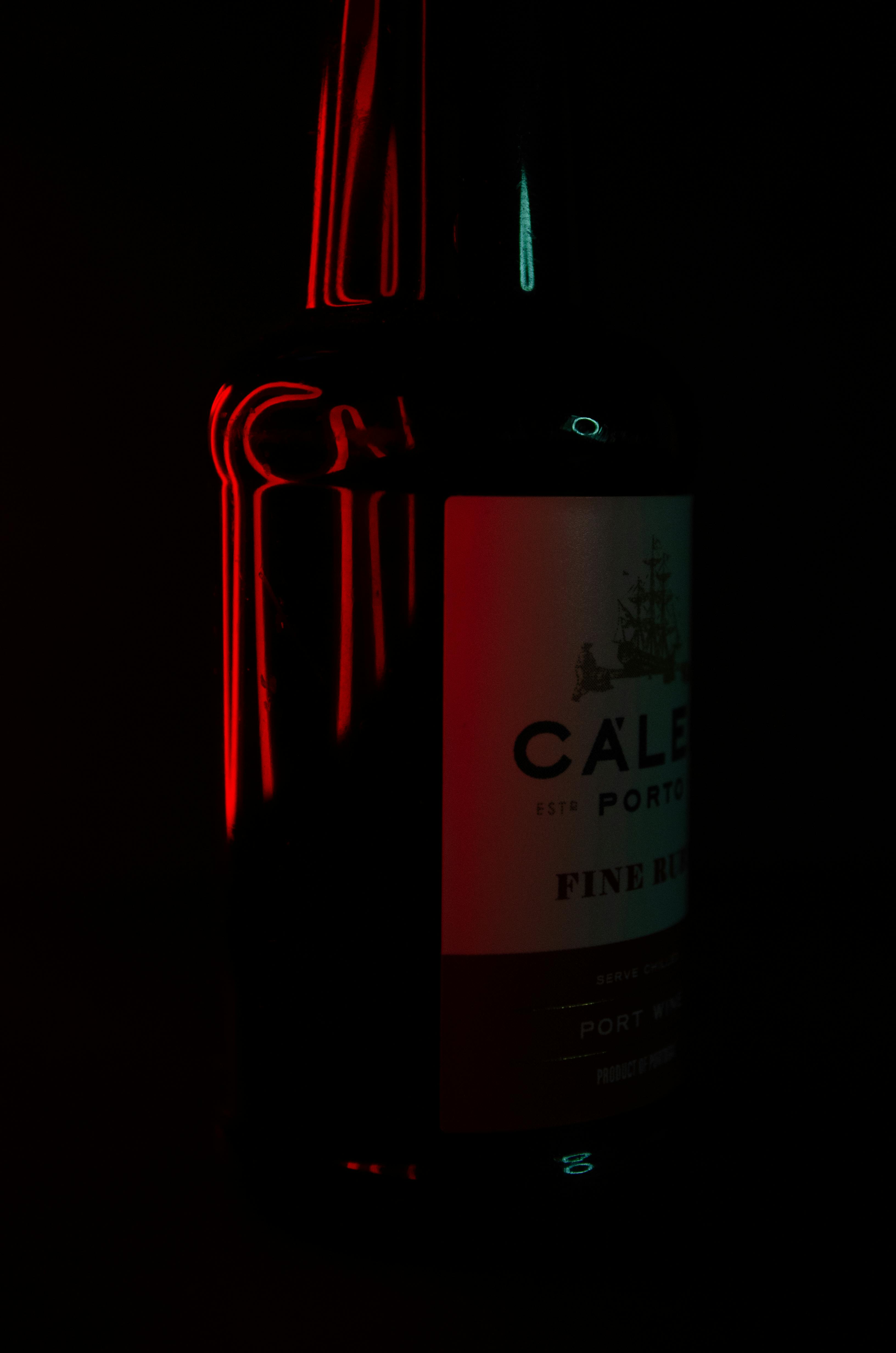 Close-Up Photo of a Bottle Illuminated by a Red Light · Free Stock Photo