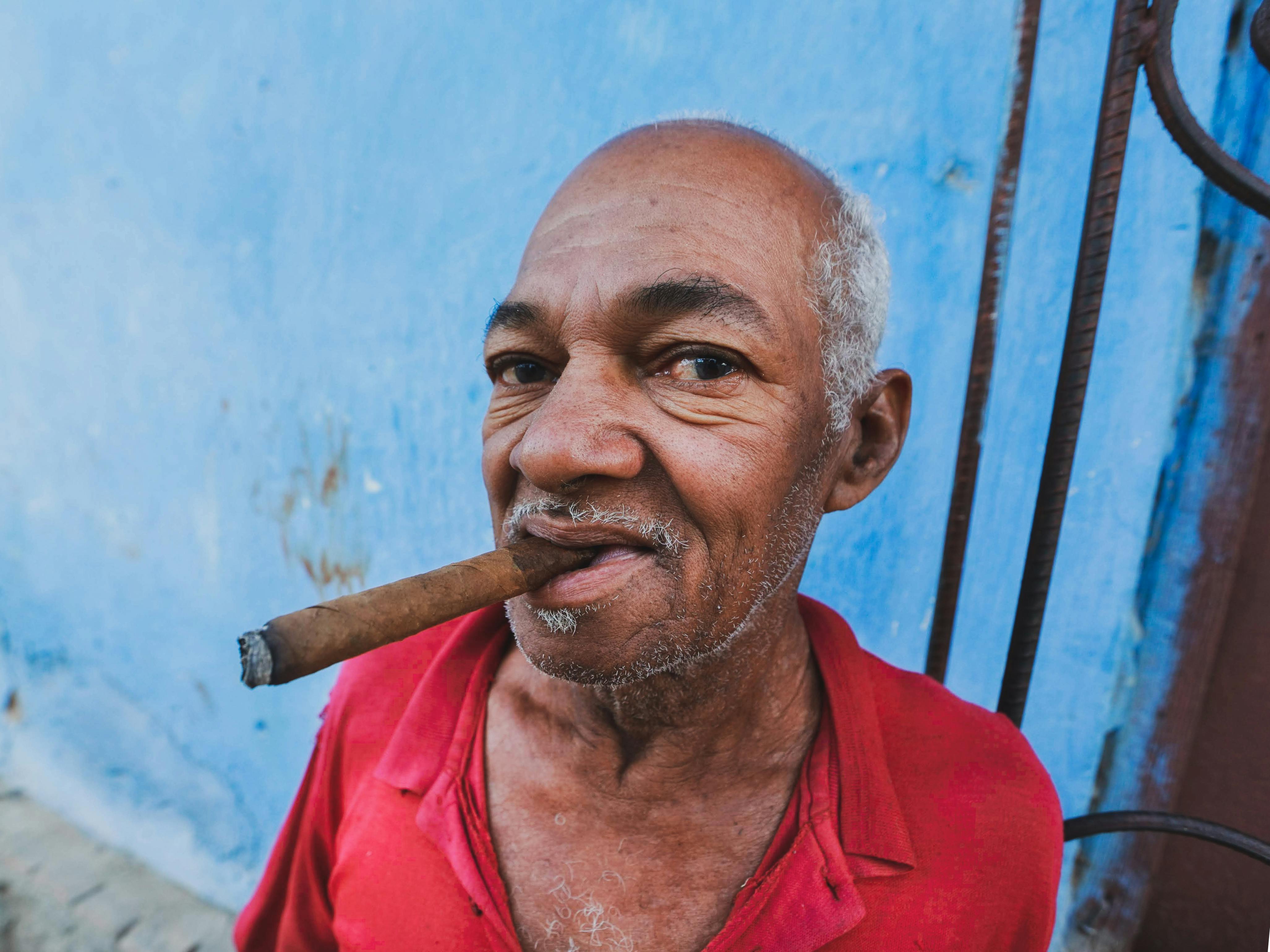 Man in Blue Kitchen Apron Holding Knife and Chopping Board With Sliced ...